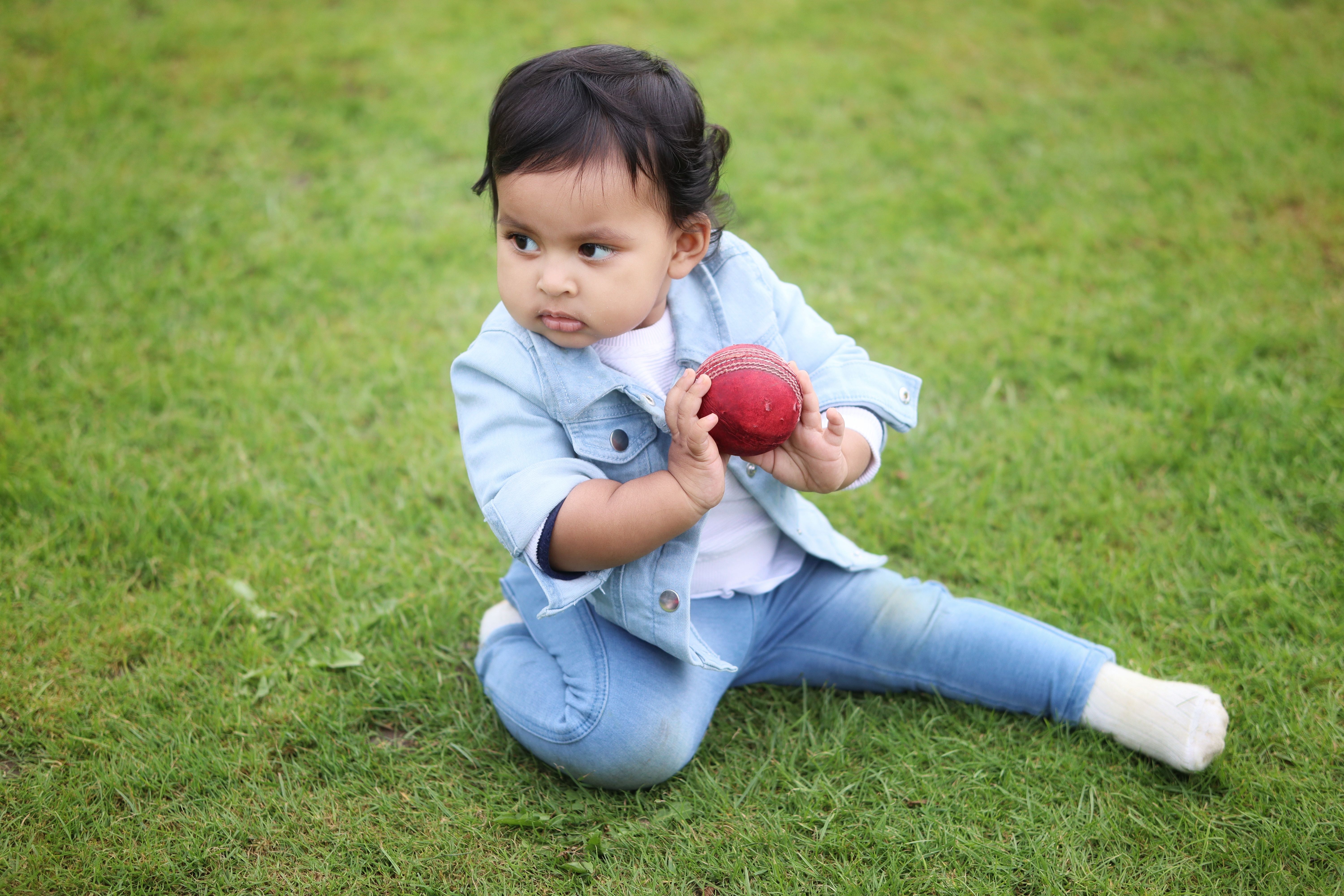 Photograph of a Child Holding a Red Ball · Free Stock Photo