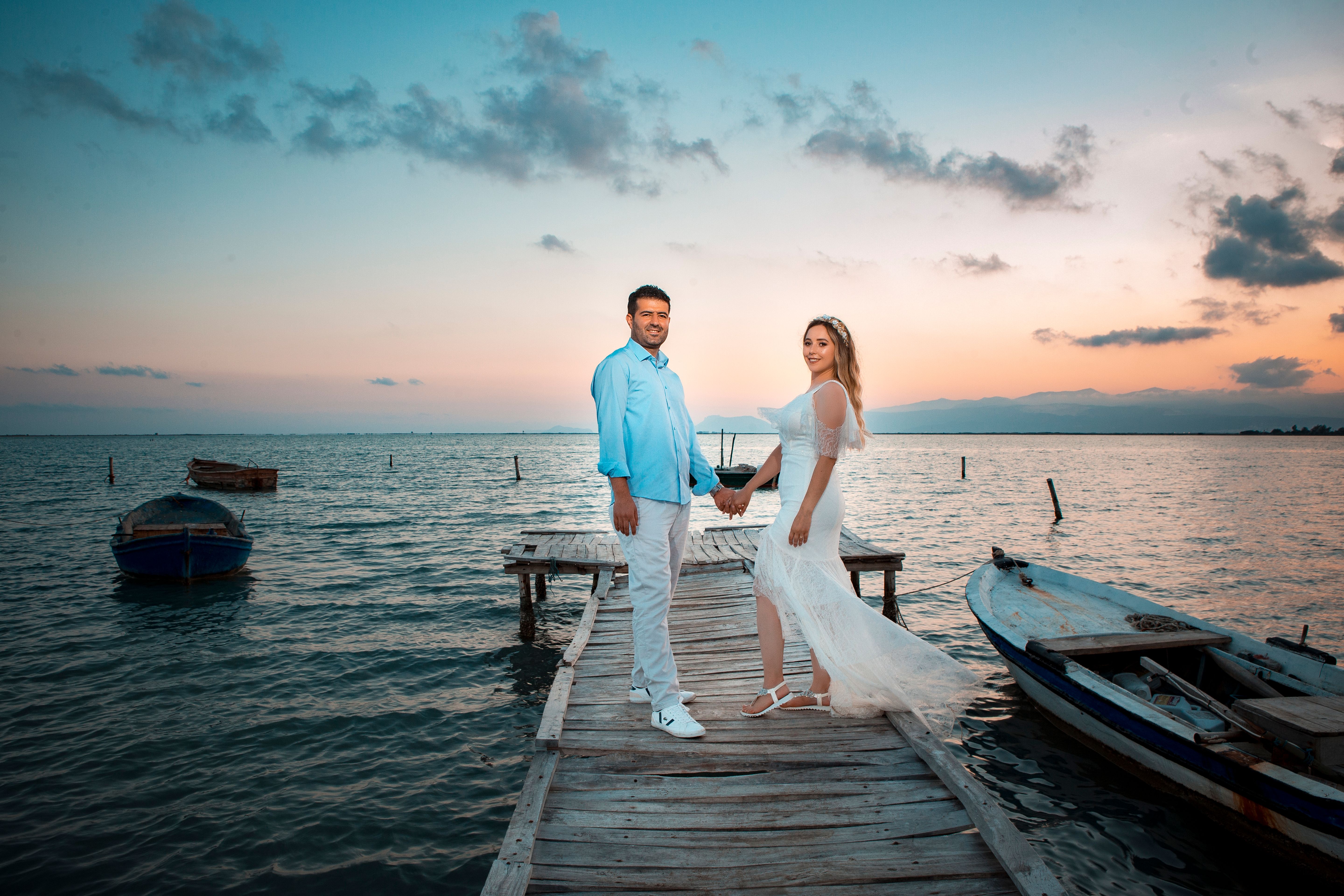 Married Couple on a Wooden Jetty at Sunset · Free Stock Photo