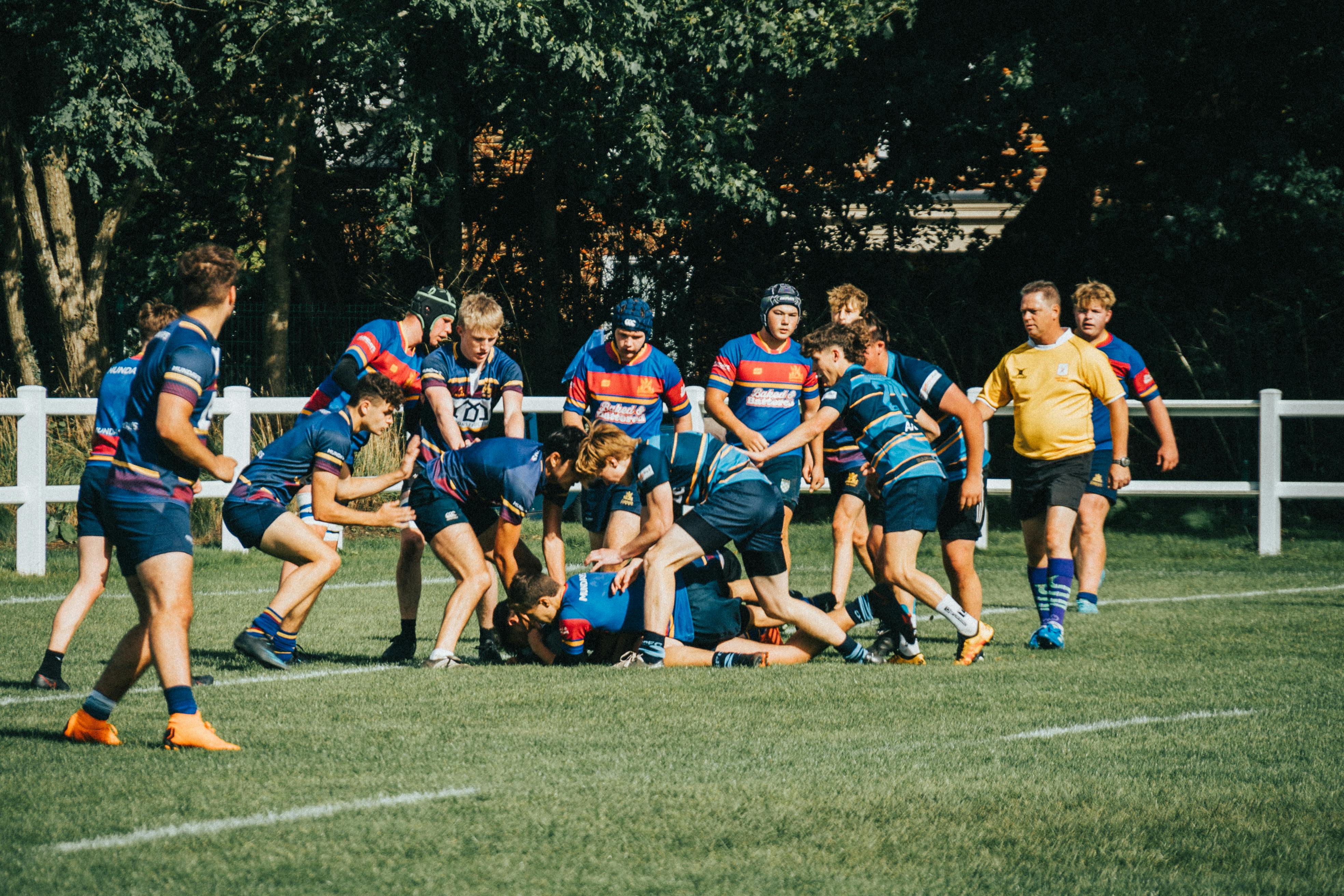 Men in Uniform Playing Rugby on Field · Free Stock Photo