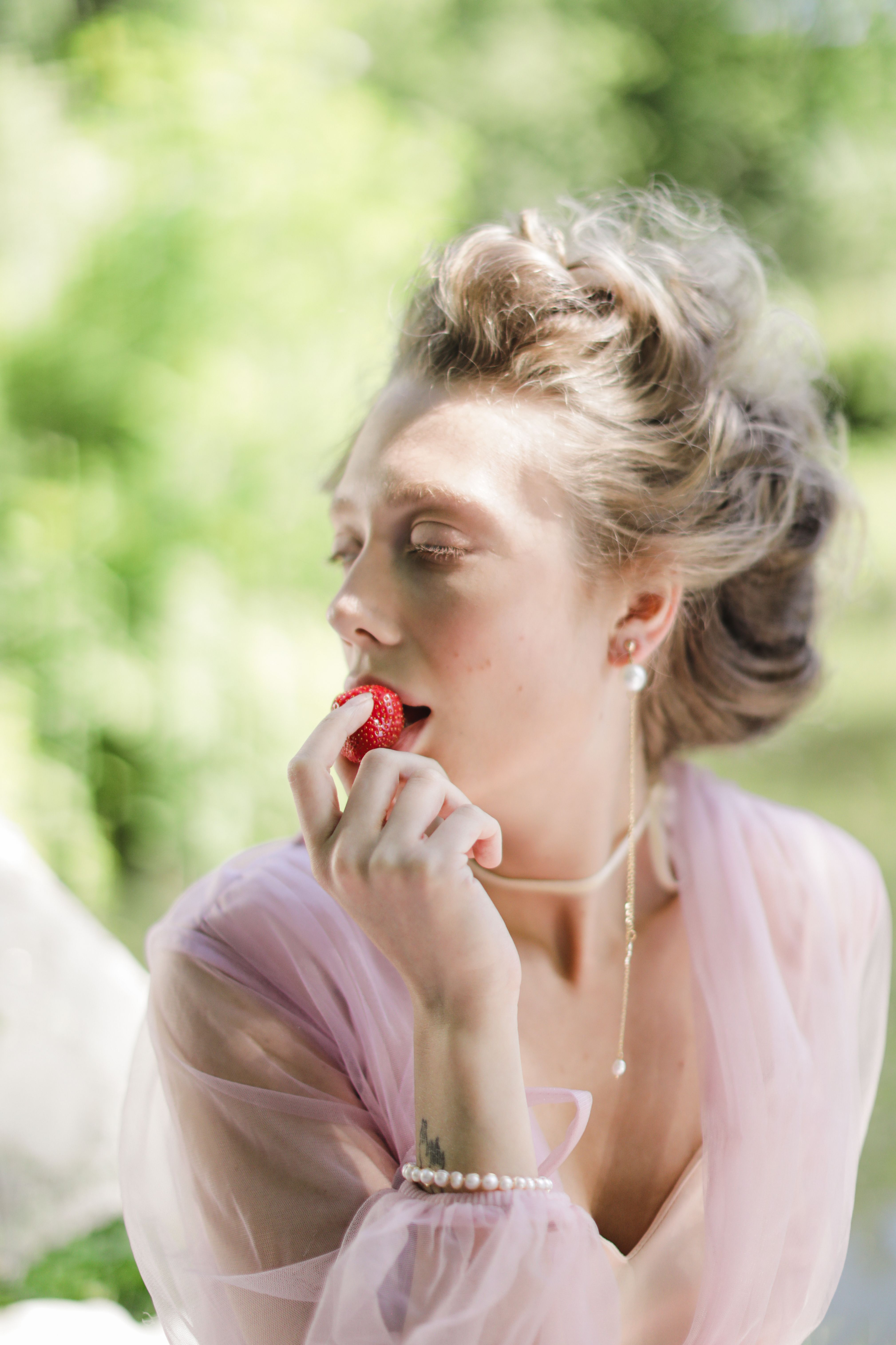 Woman Eating a Strawberry · Free Stock Photo