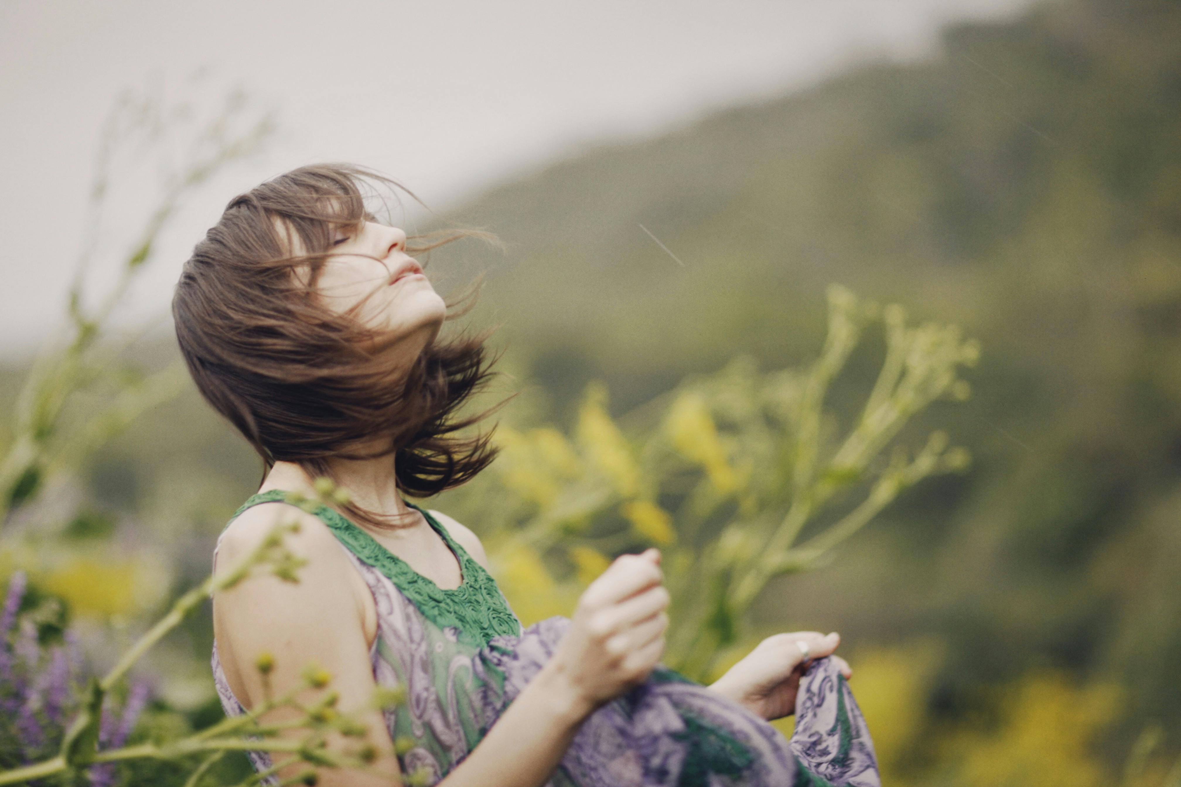 Profile of woman in dress with wind rustling her hair · Free Stock Photo