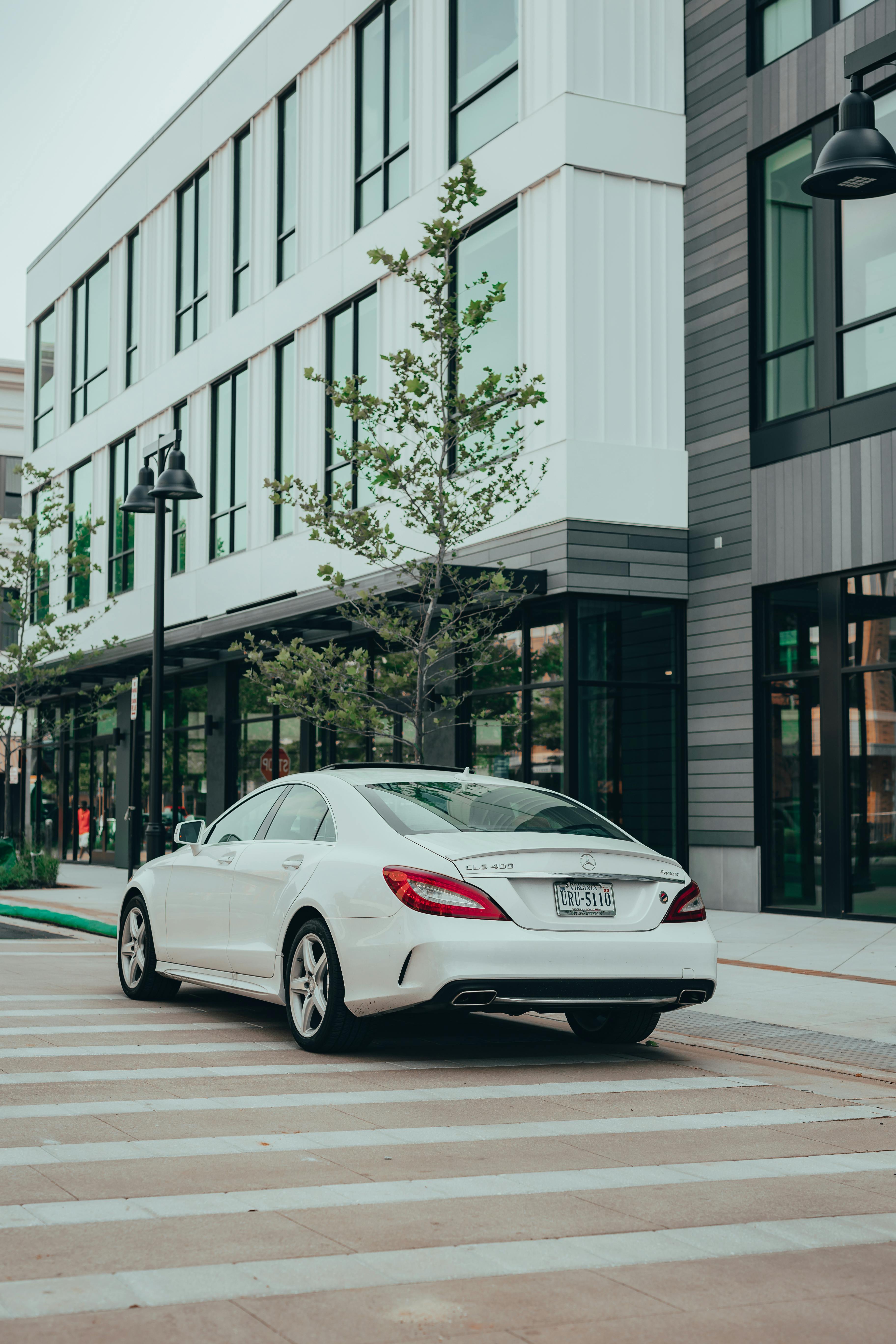 White Sedan on Road Near Building · Free Stock Photo