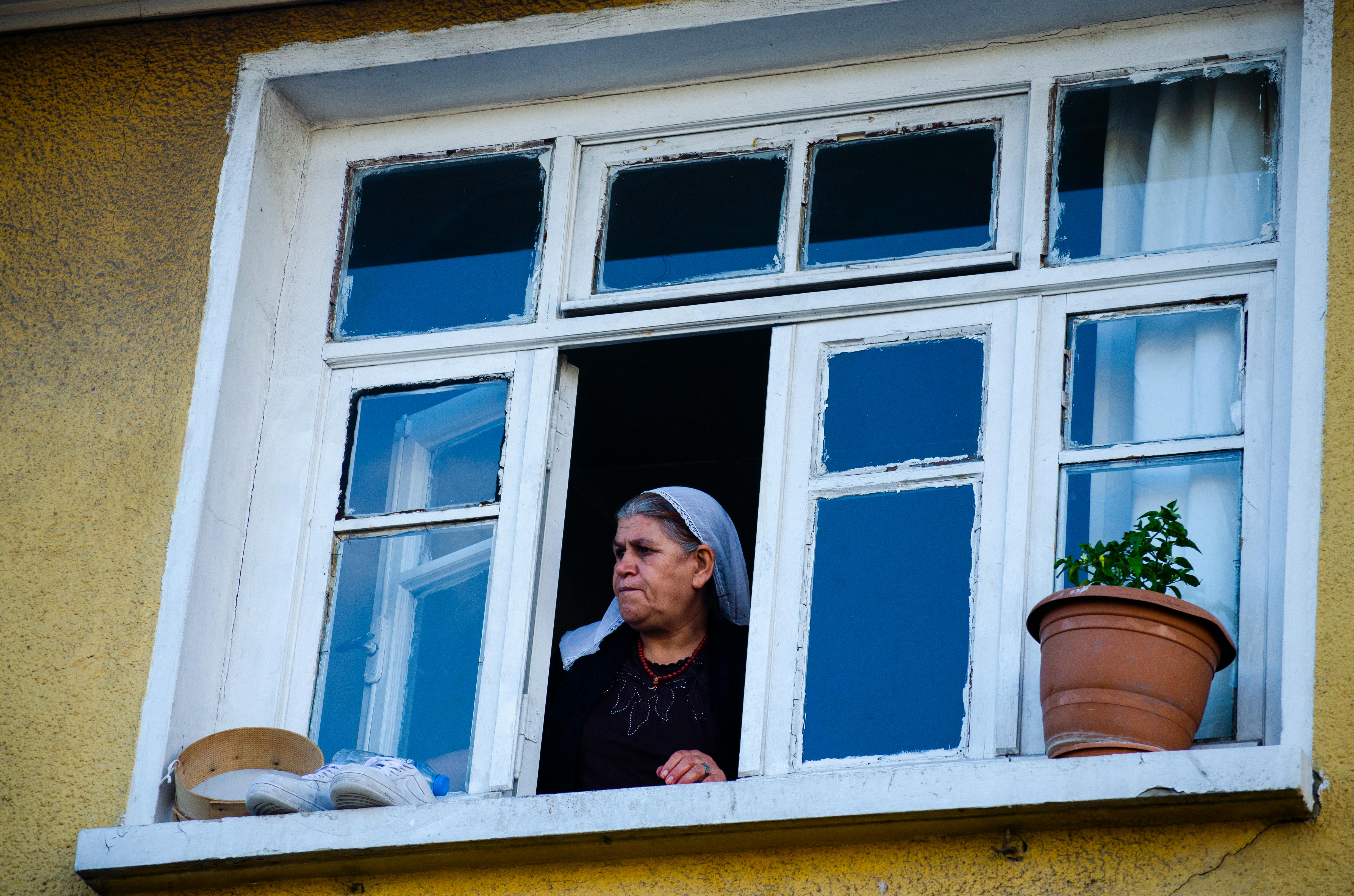 Old Woman Looking out of House Window · Free Stock Photo