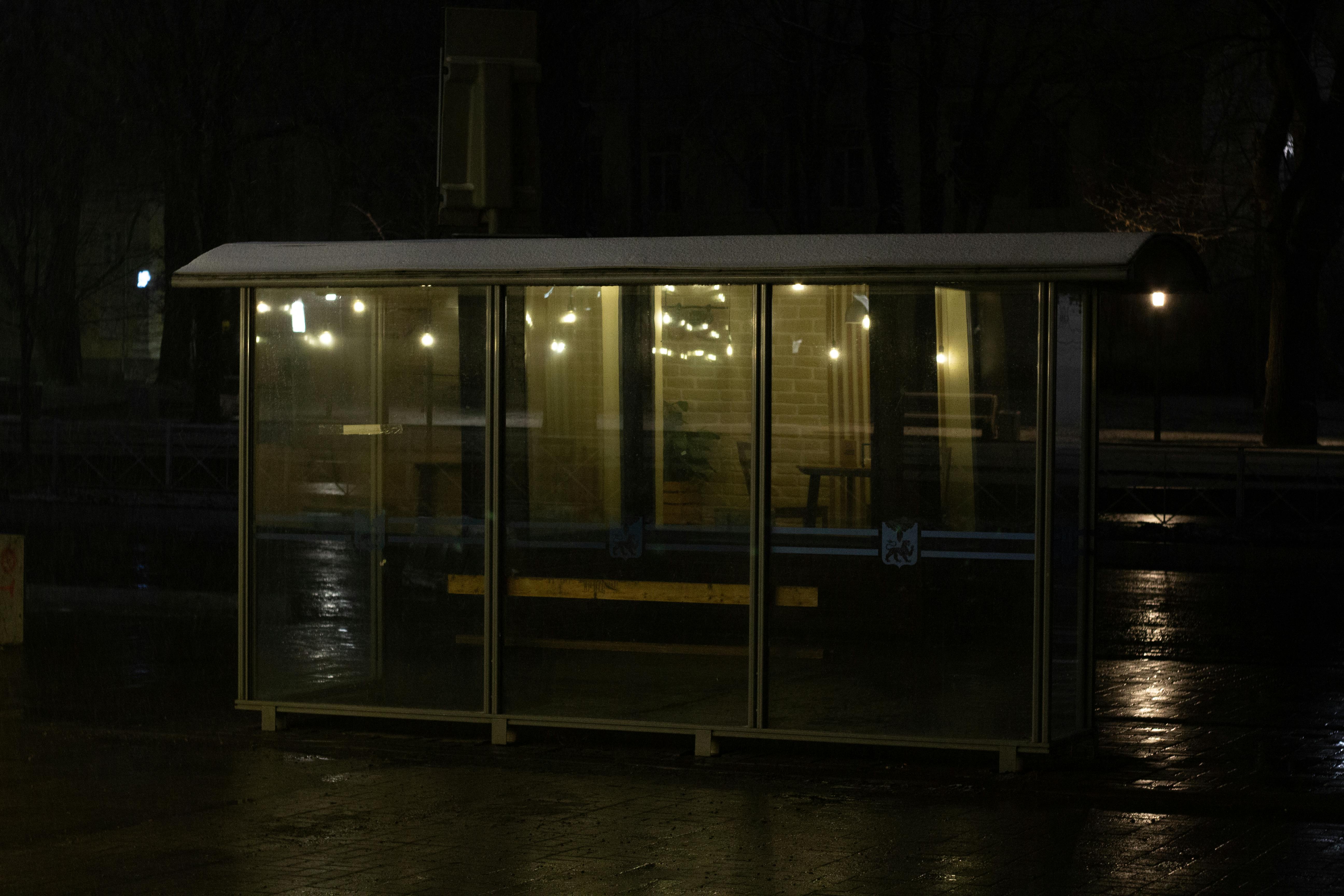 A Glass Waiting Shed at Night · Free Stock Photo