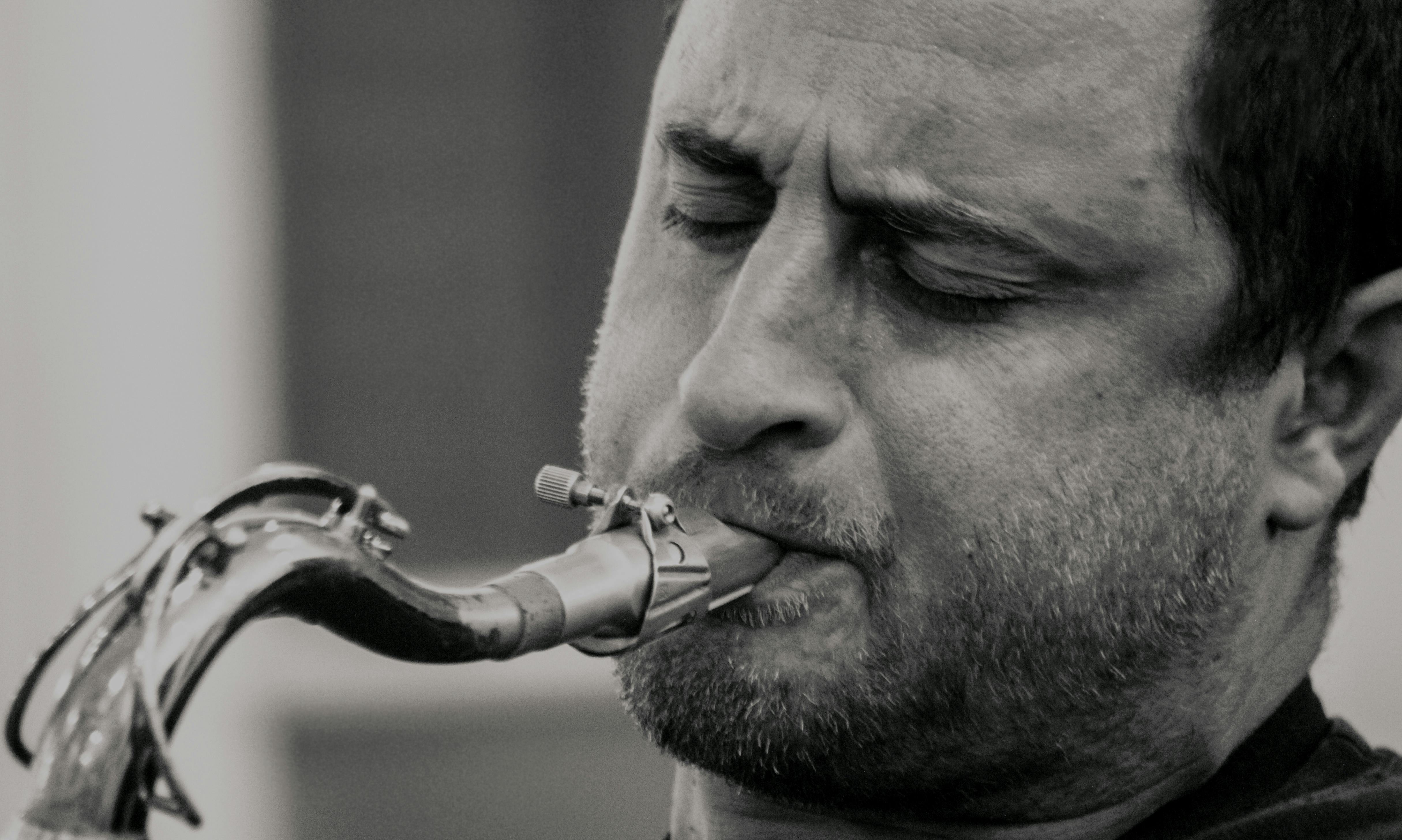 Grayscale Photo of a Man Playing a Saxophone · Free Stock Photo