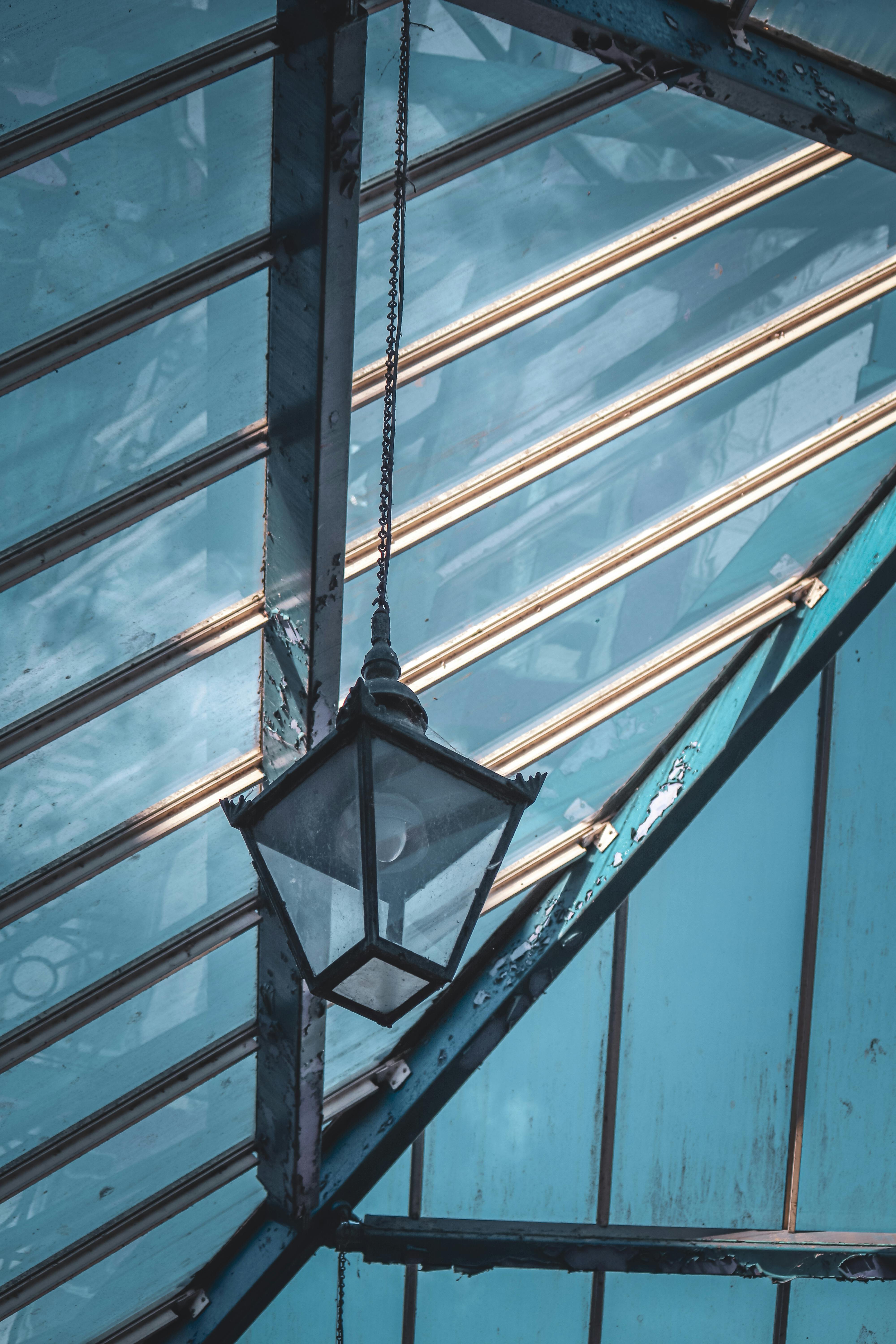 Photo of a Hanging Light Near Glass Windows · Free Stock Photo