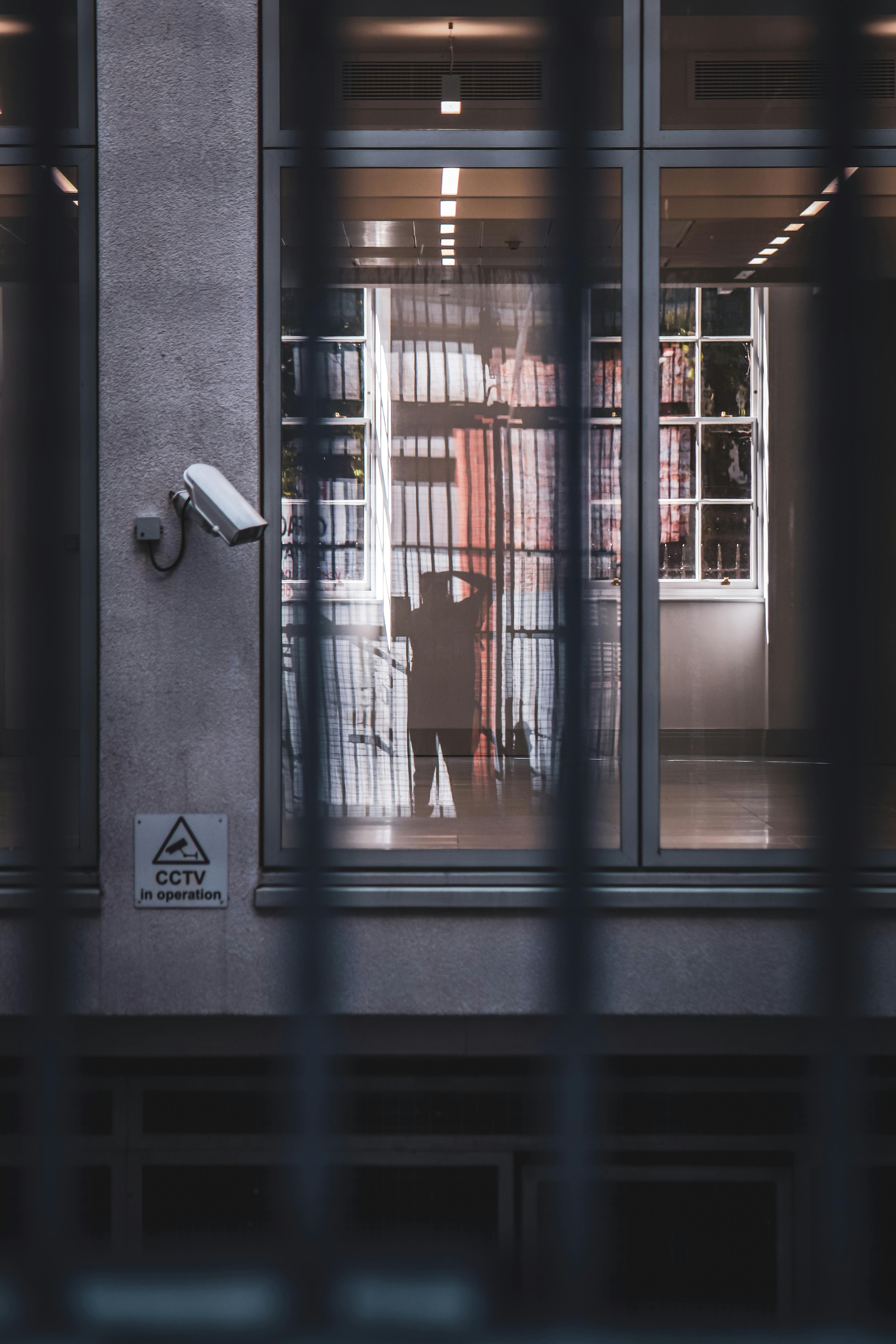 Reflection of standing man in window · Free Stock Photo