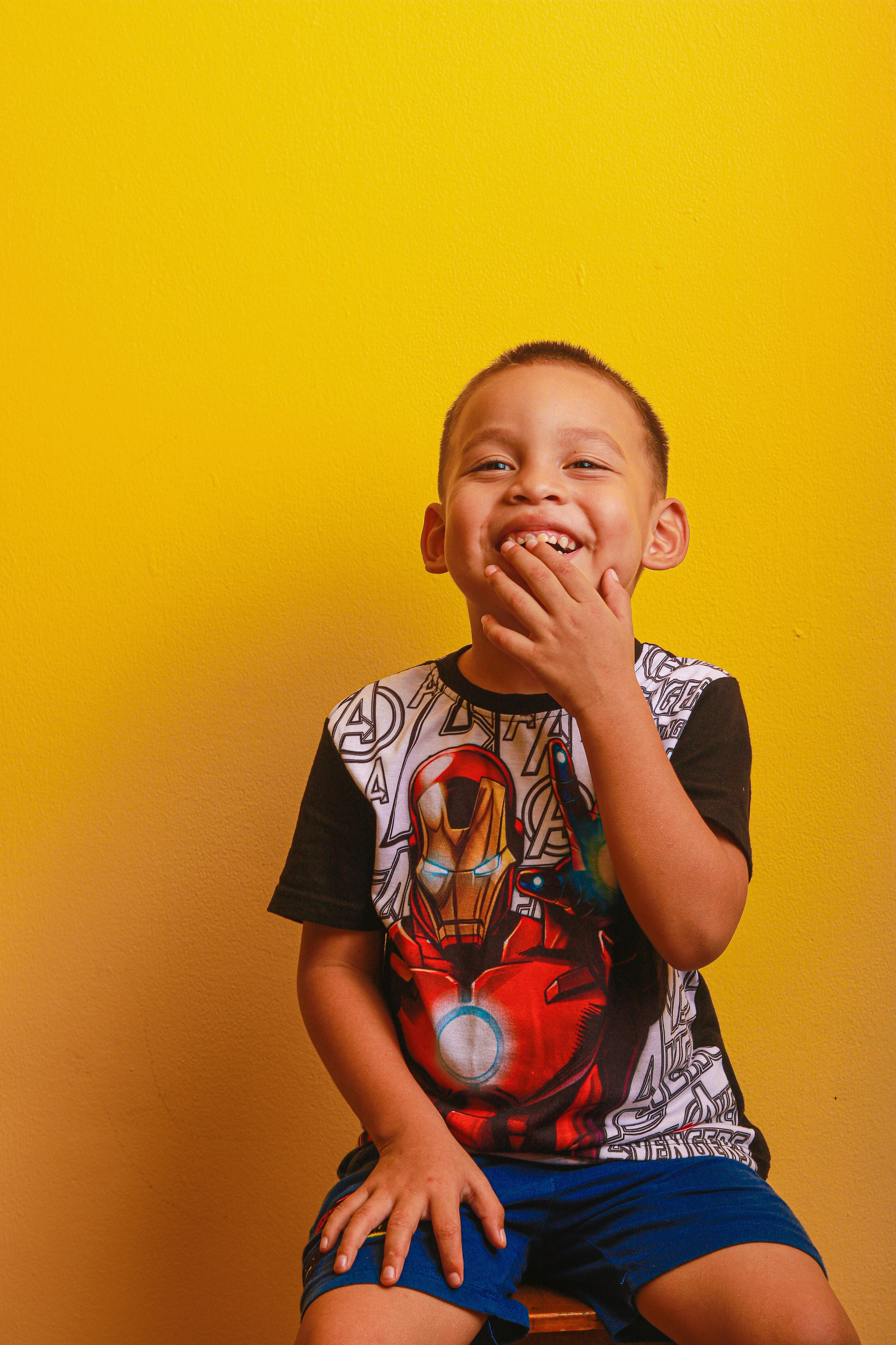Smiling Young Boy in Yellow Background · Free Stock Photo