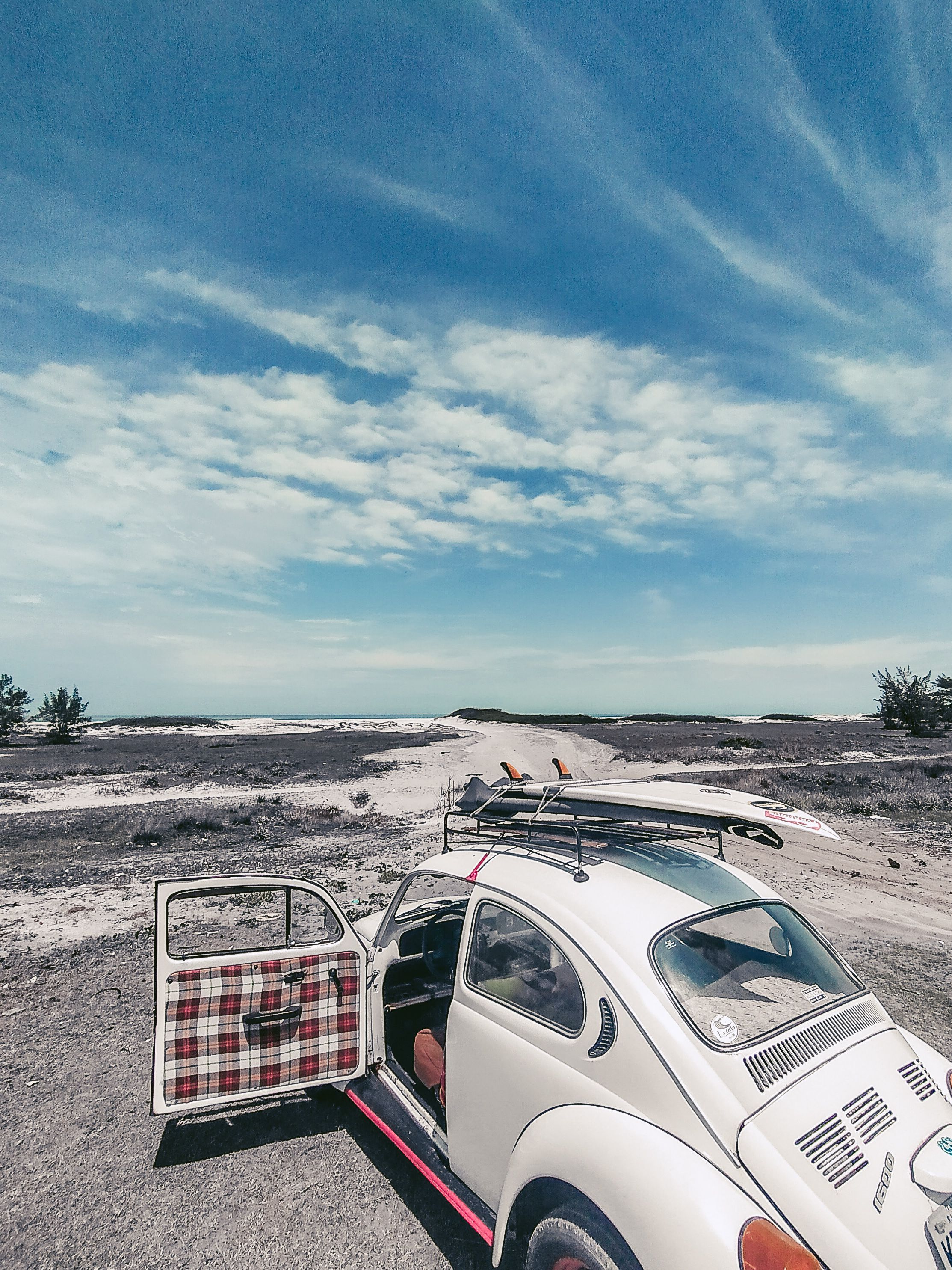 Scenic View of White Volkswagen Beetle Under the Blue Sky · Free Stock ...