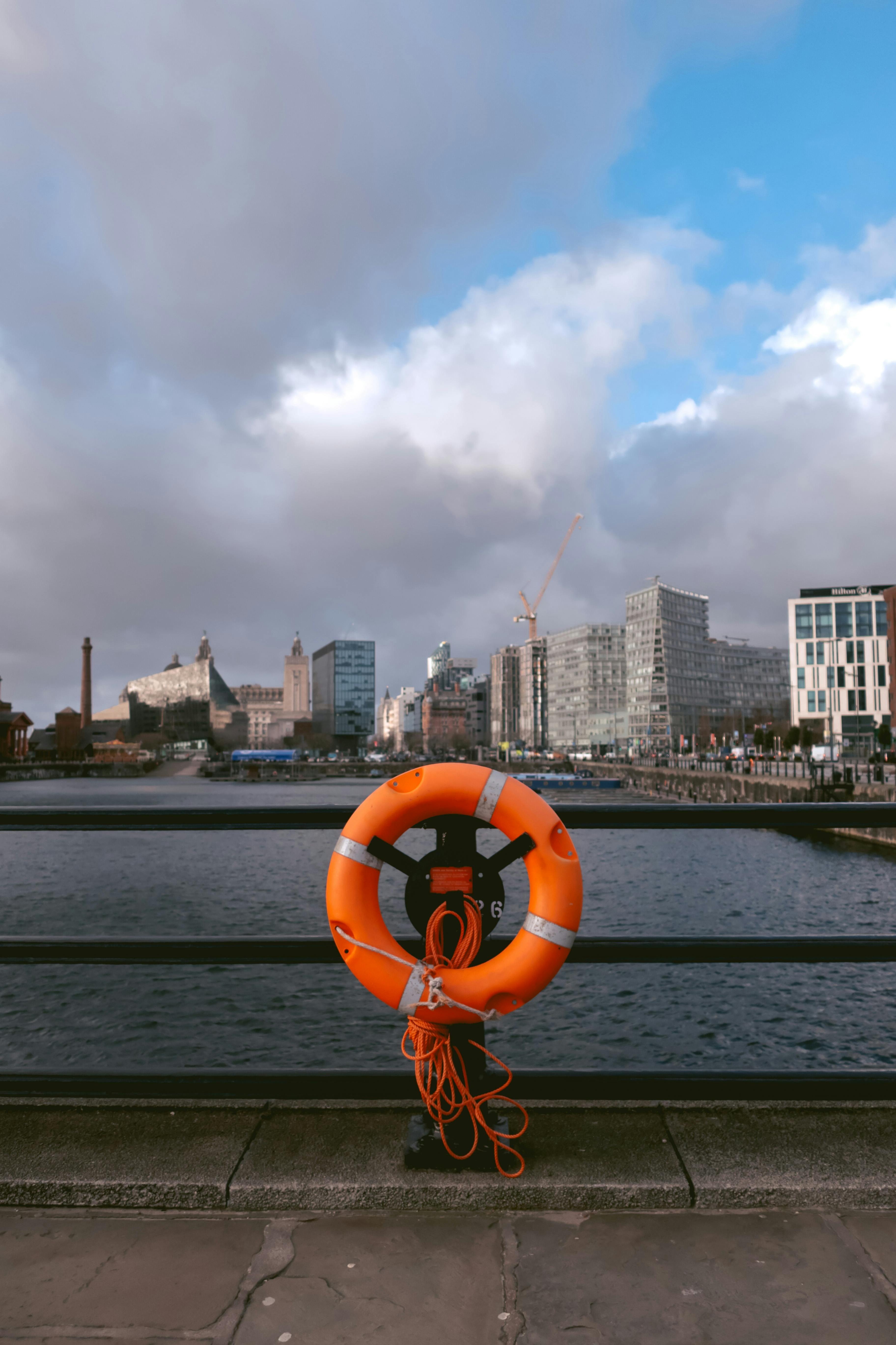 An Orange Floater with Rope on Railings Near River · Free Stock Photo