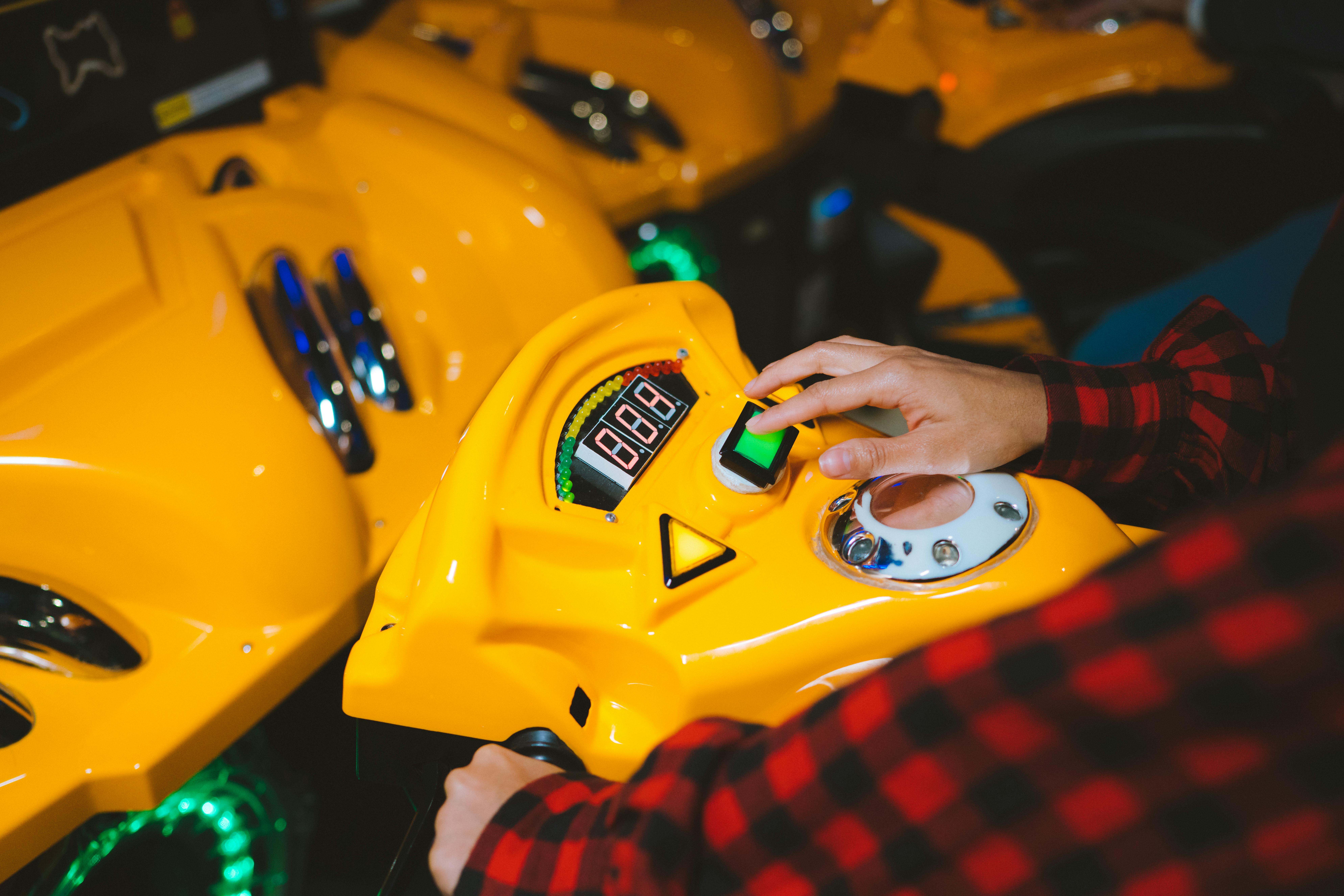 Close-Up Shot of a Person Playing an Arcade Game · Free Stock Photo