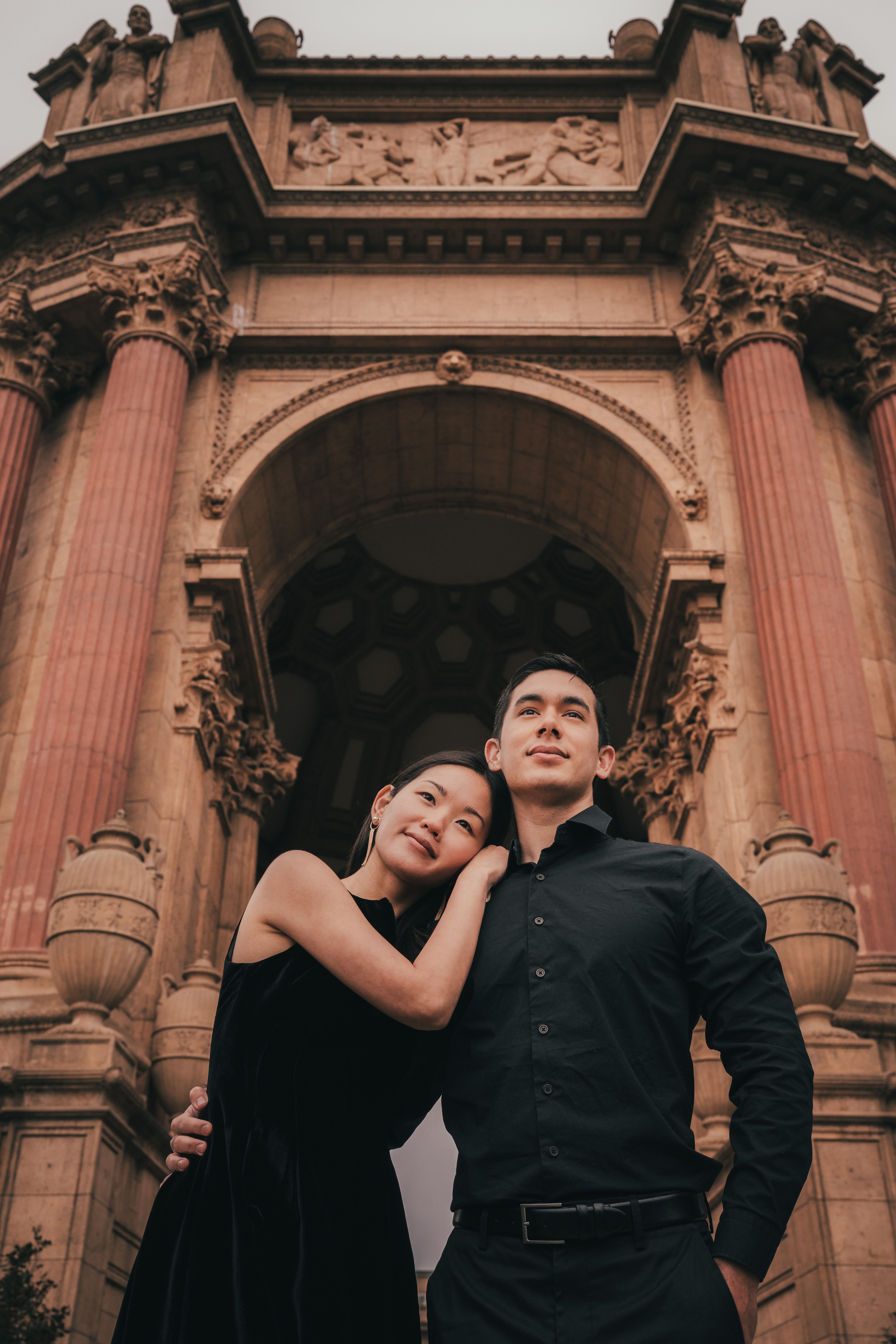 Man Hugging a Woman Beside a Building · Free Stock Photo