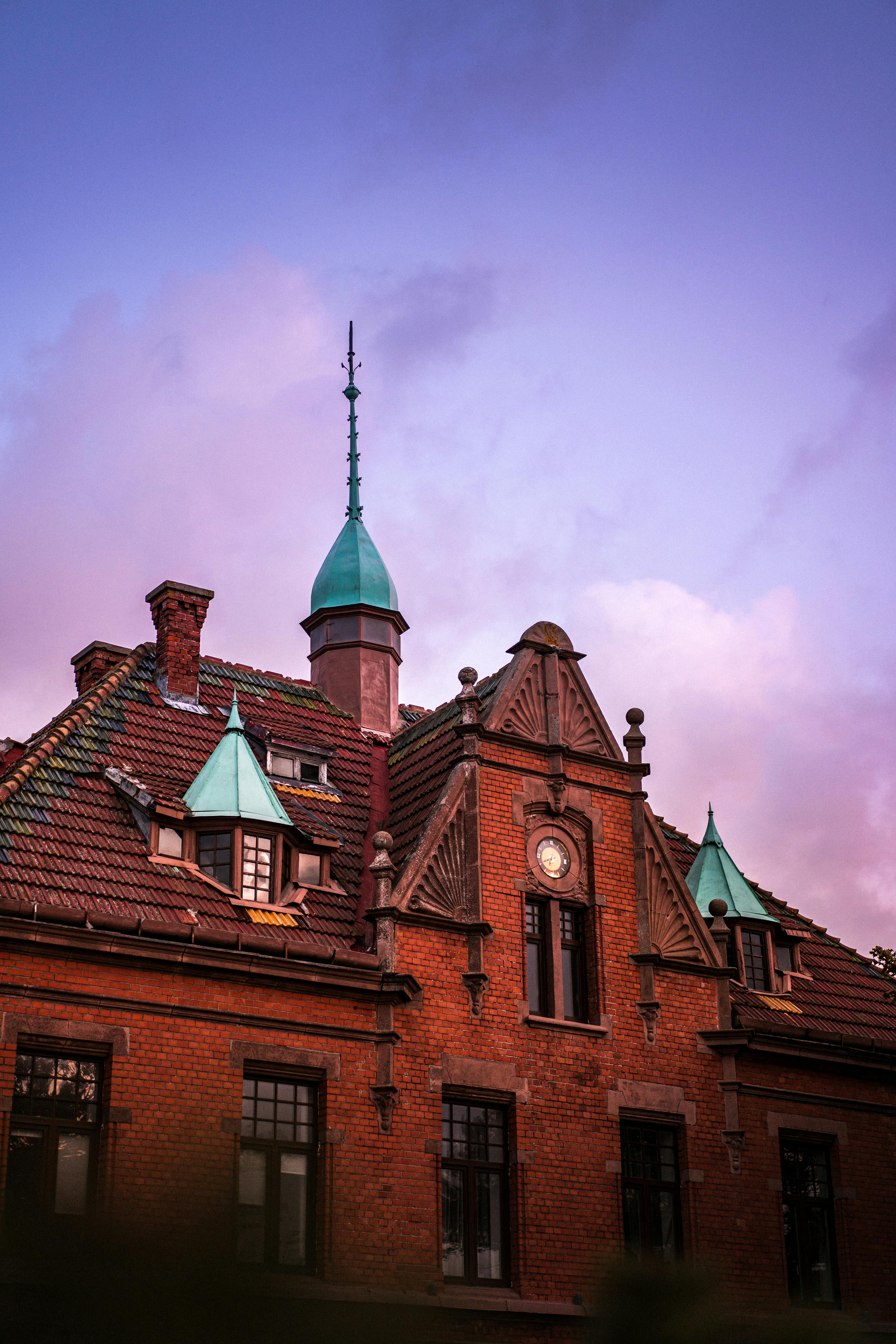 Brick Building with Spire at Sunset · Free Stock Photo