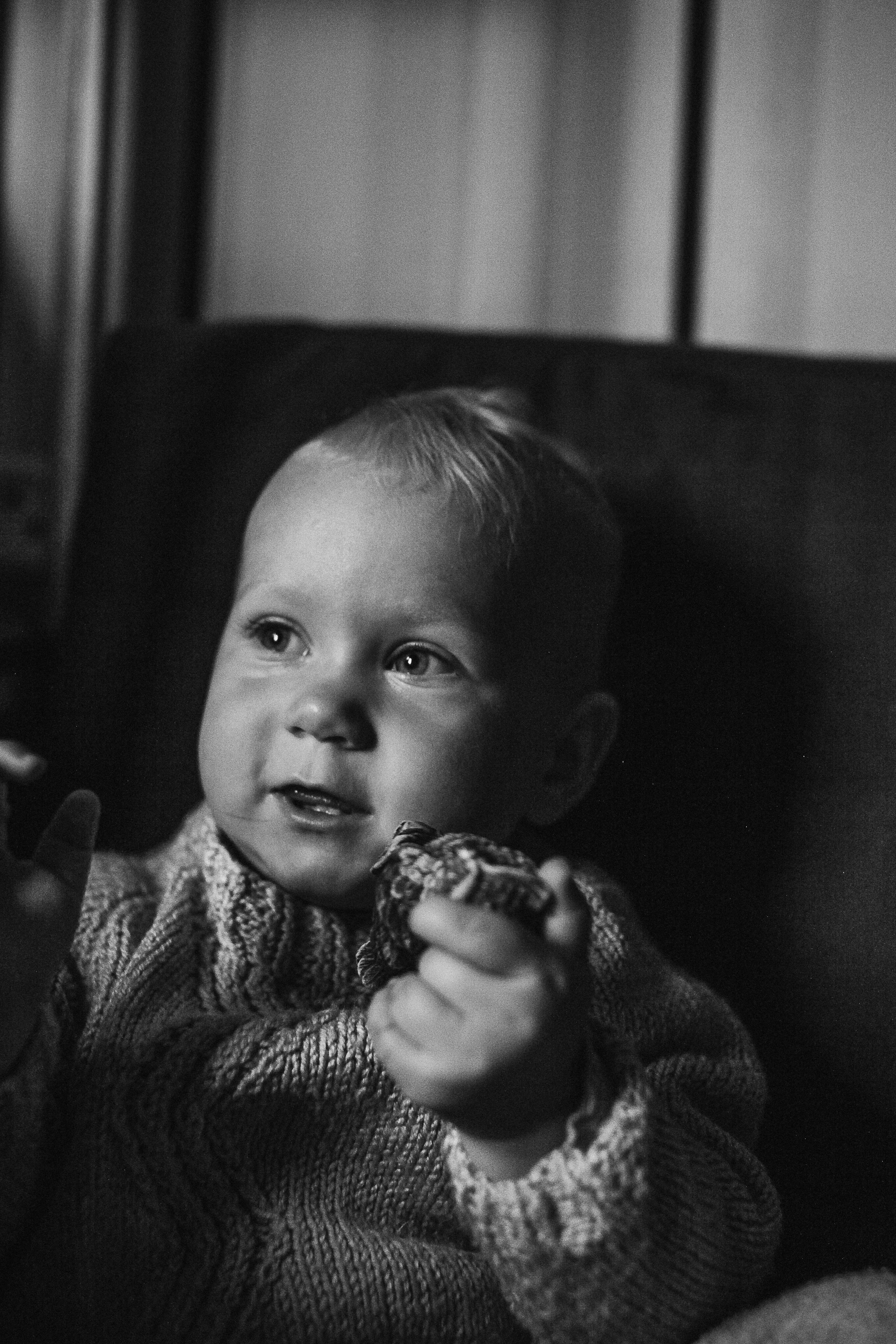 Grayscale Photo of Baby in Knitted Sweater · Free Stock Photo