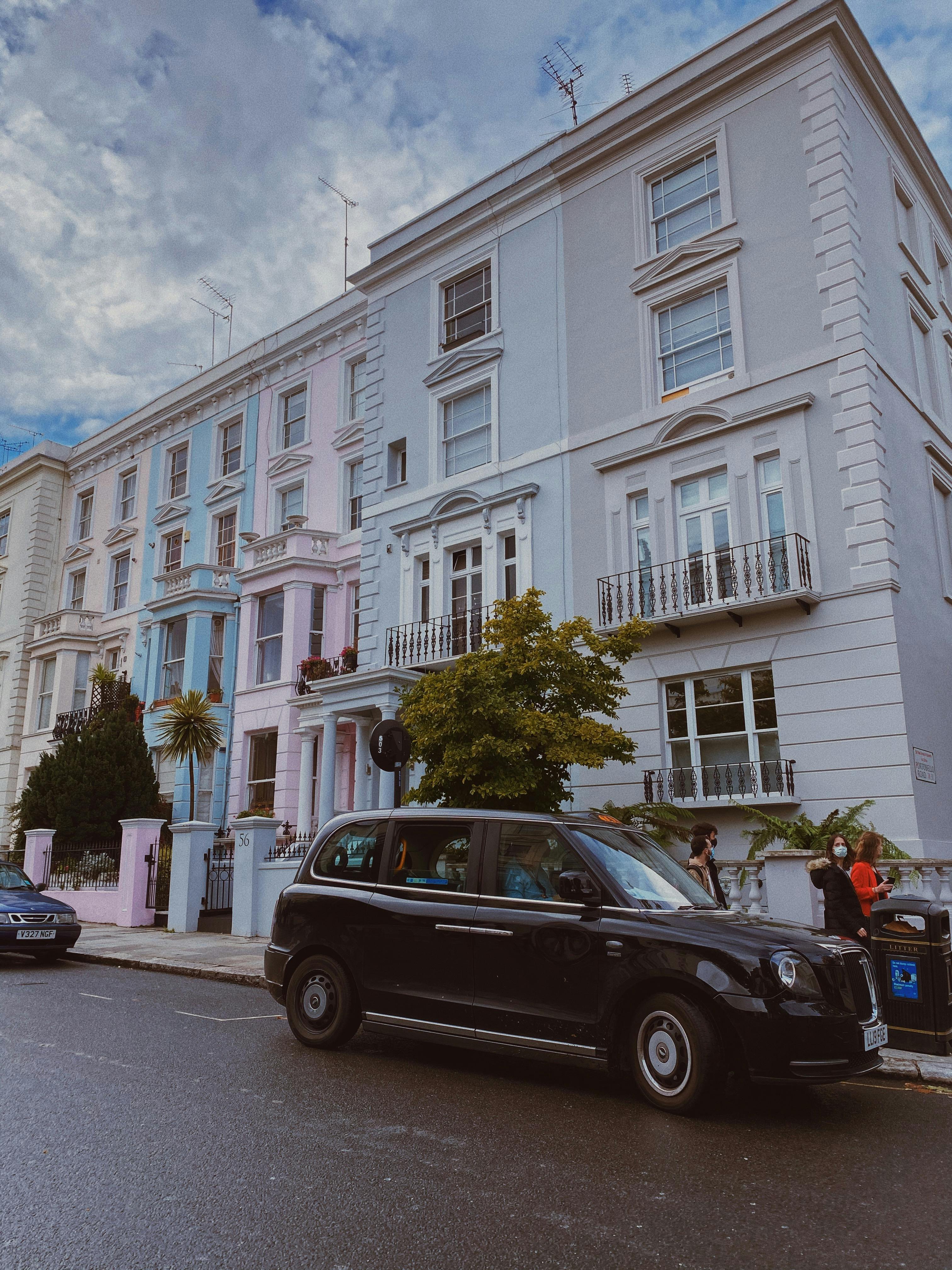 Car Parked Beside Concrete Building · Free Stock Photo