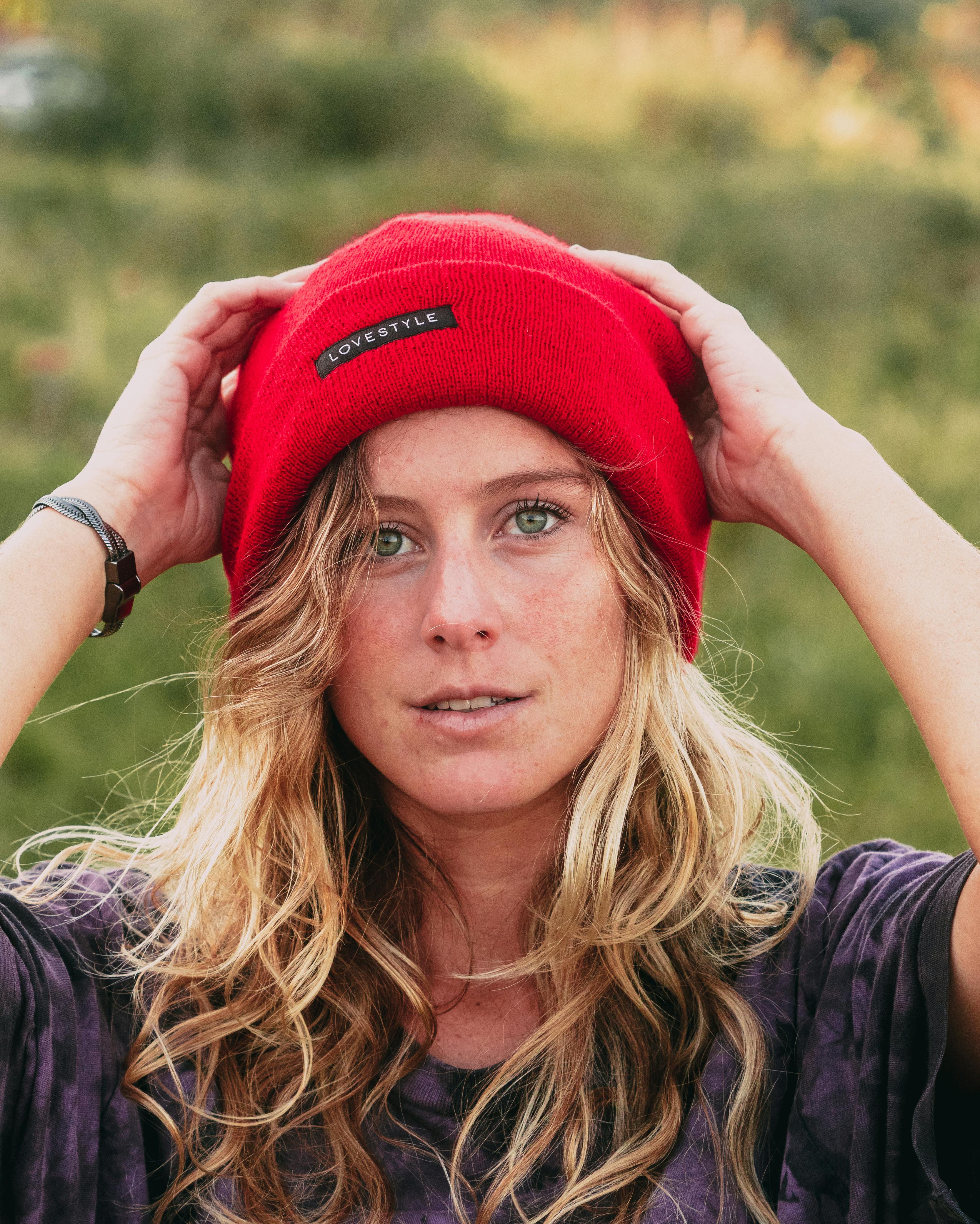 Headshot of a Pretty Woman Wearing a Red Knitted Cap · Free Stock Photo