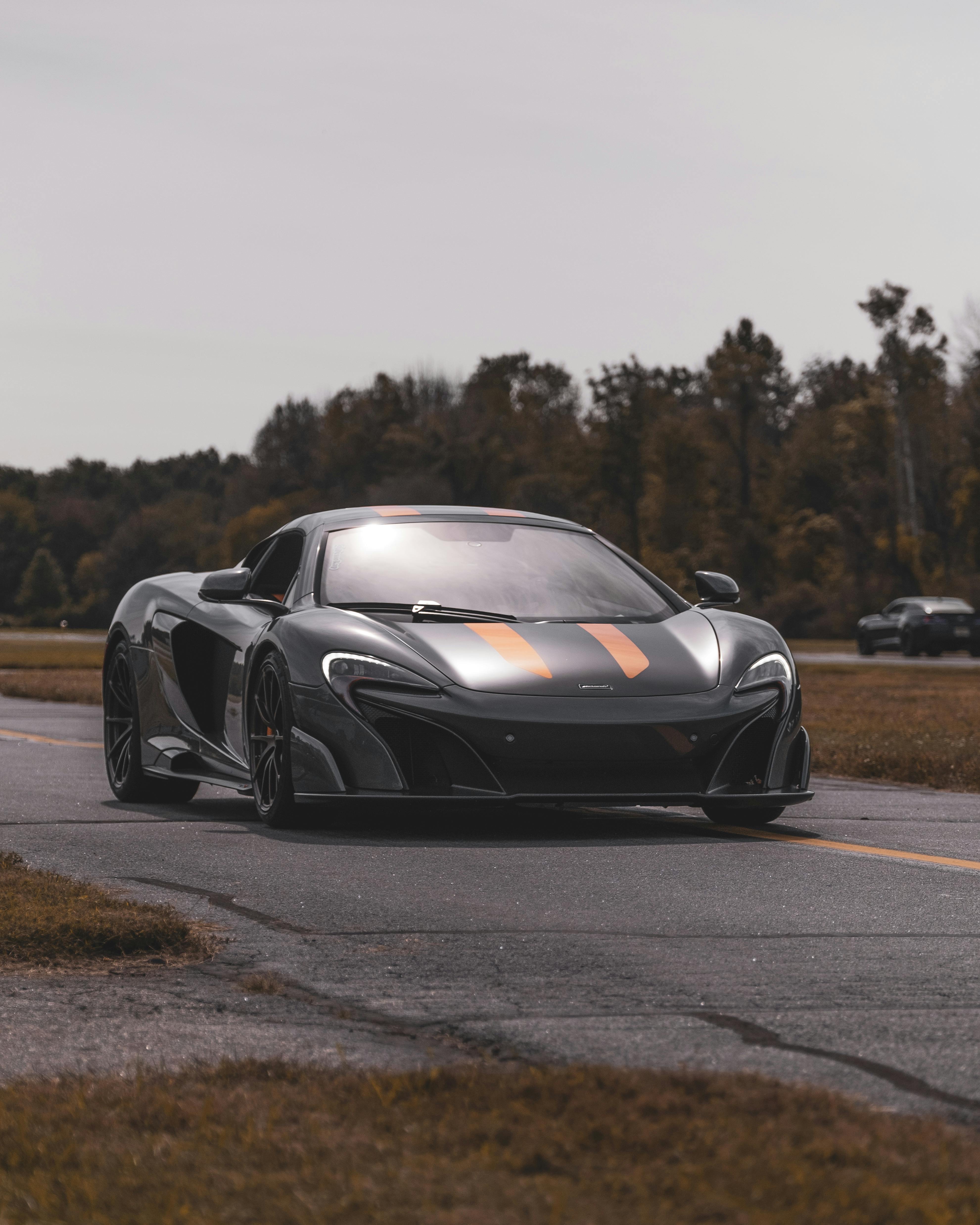 A Black Sports Car on Asphalt Road · Free Stock Photo