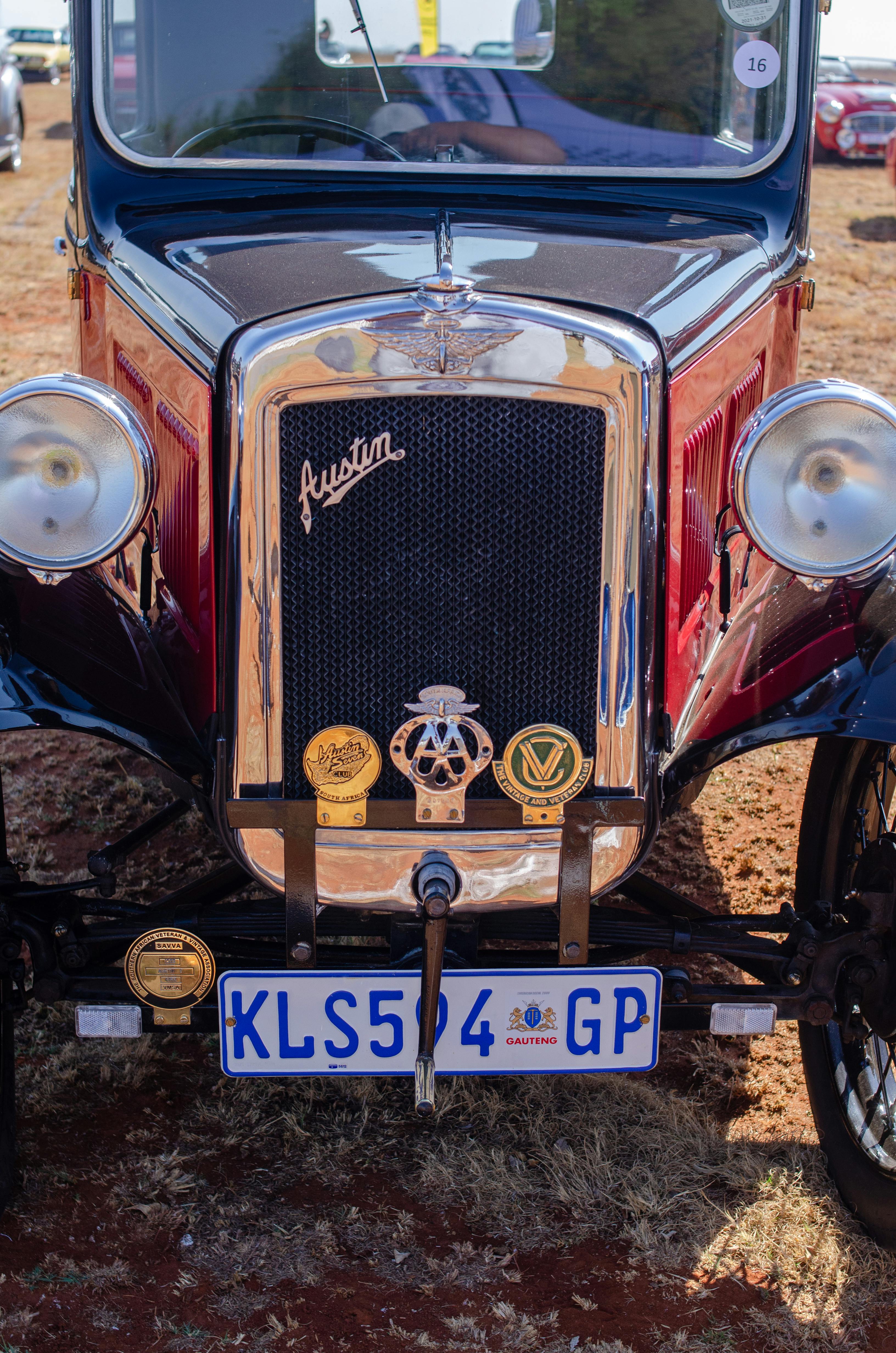 A Vintage Red Austin Car on Dirt Road · Free Stock Photo