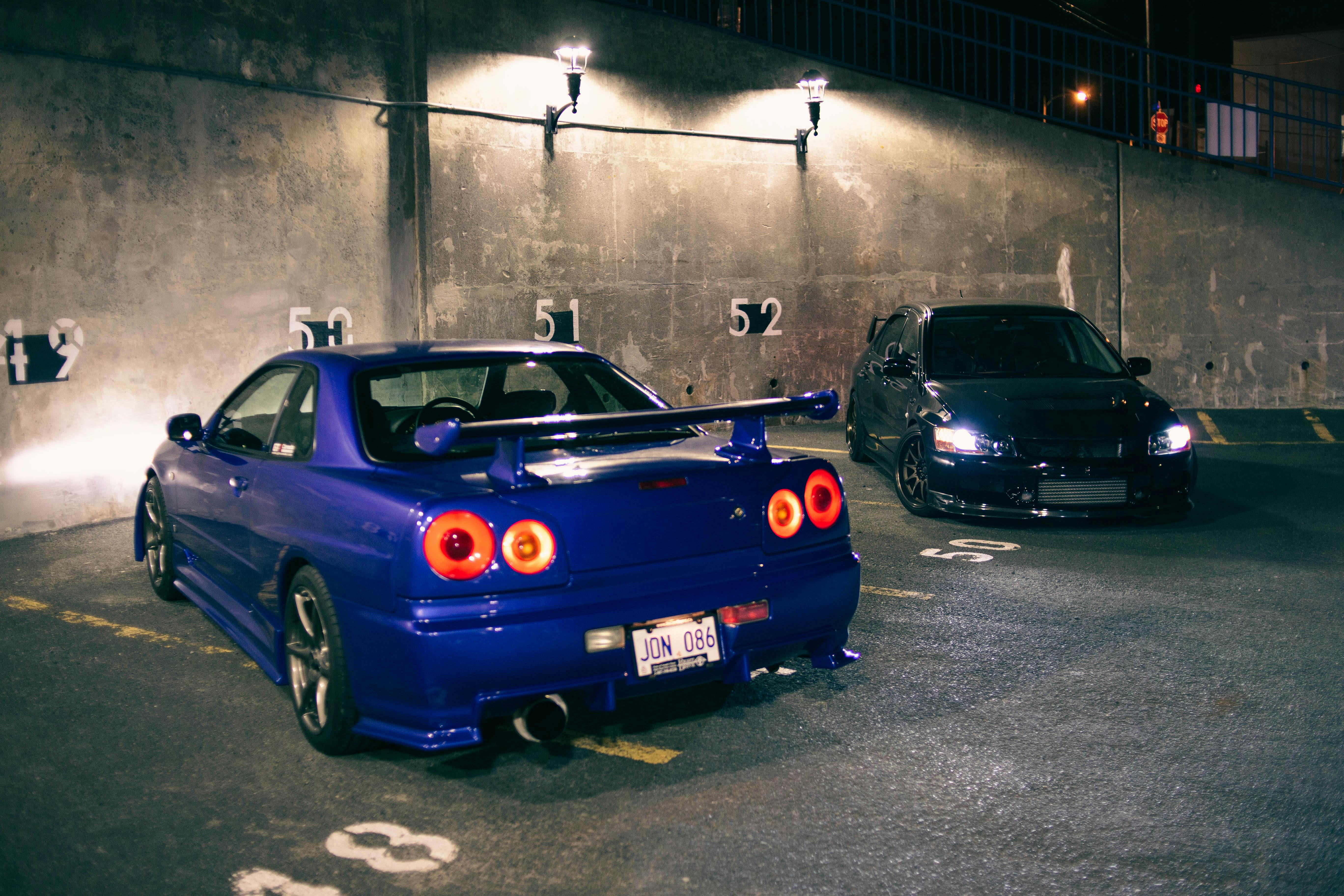Blue and Black Cars Parked on a Gray Concrete Floor · Free Stock Photo