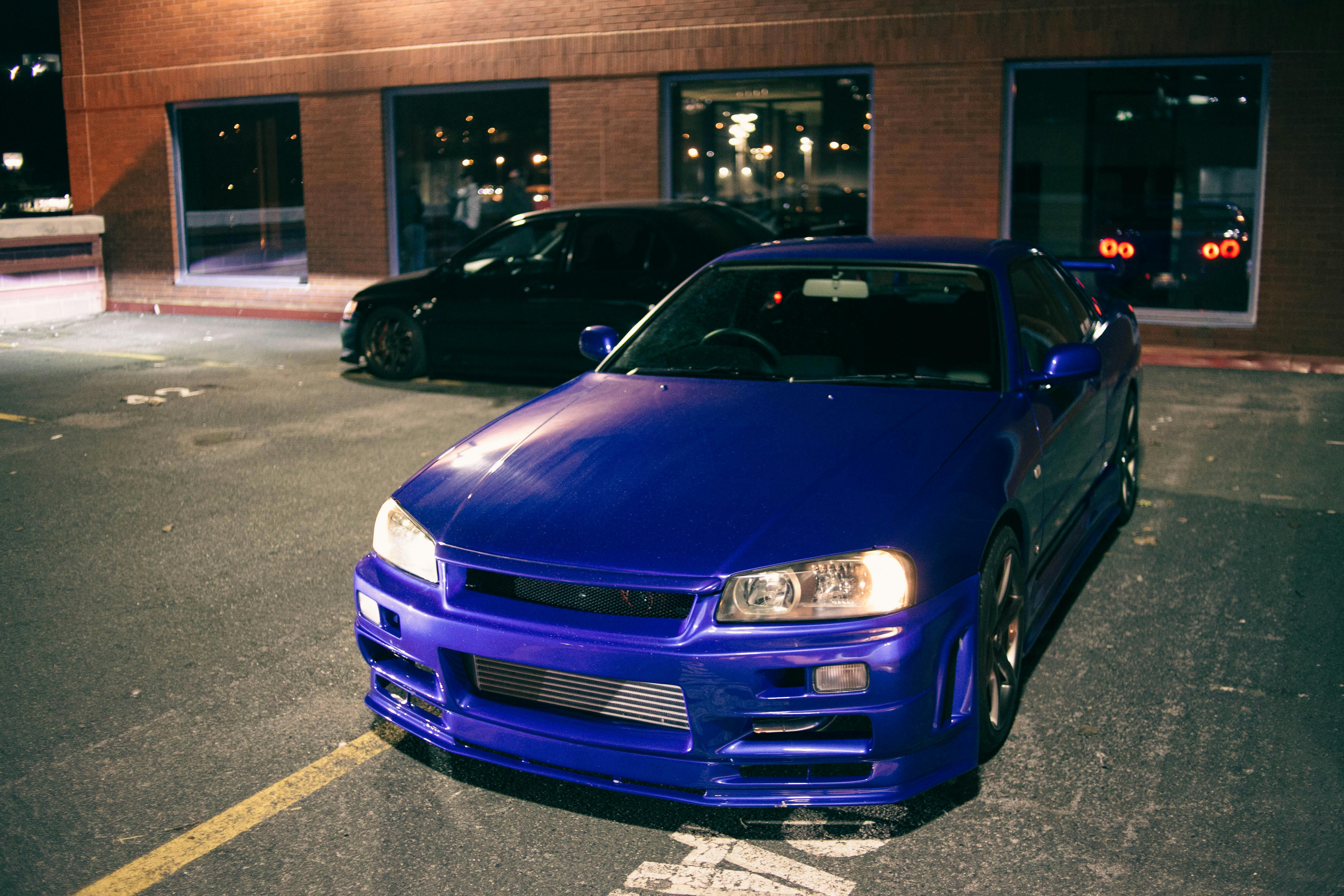 A Blue Car Parked on Asphalt Road · Free Stock Photo