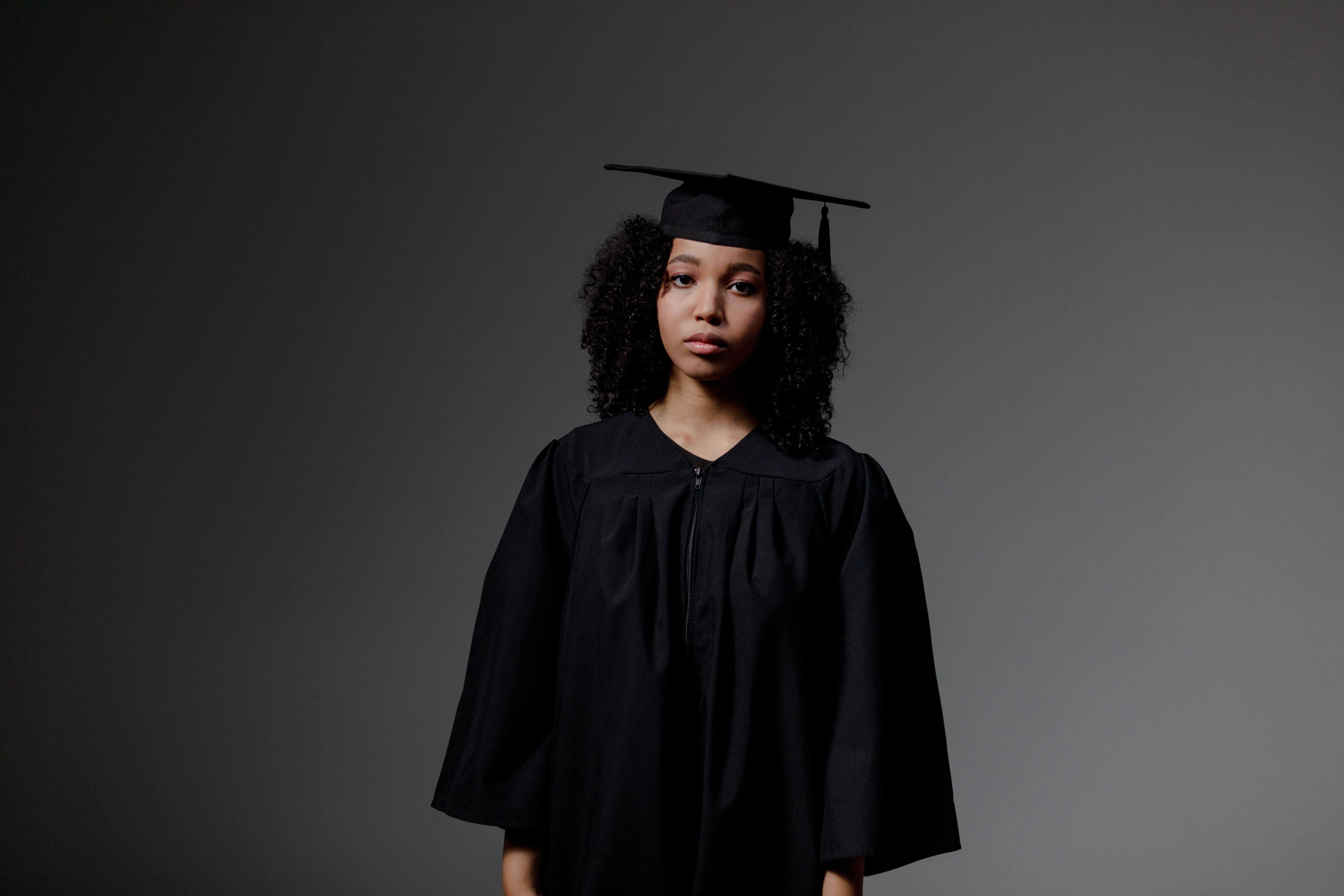 A black female student looking at camera and wearing Square academic ...
