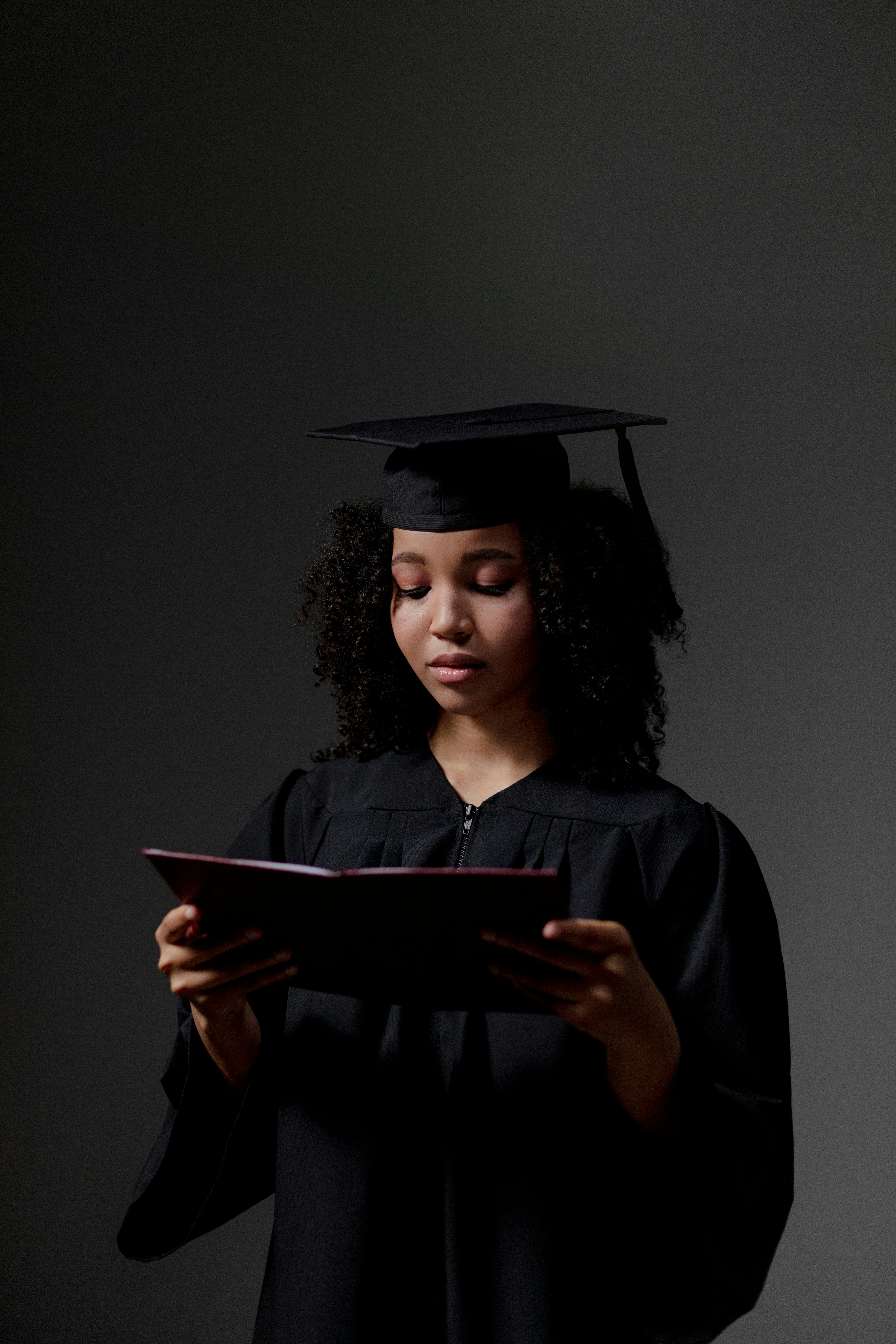Disappointed graduate student holding diploma · Free Stock Photo