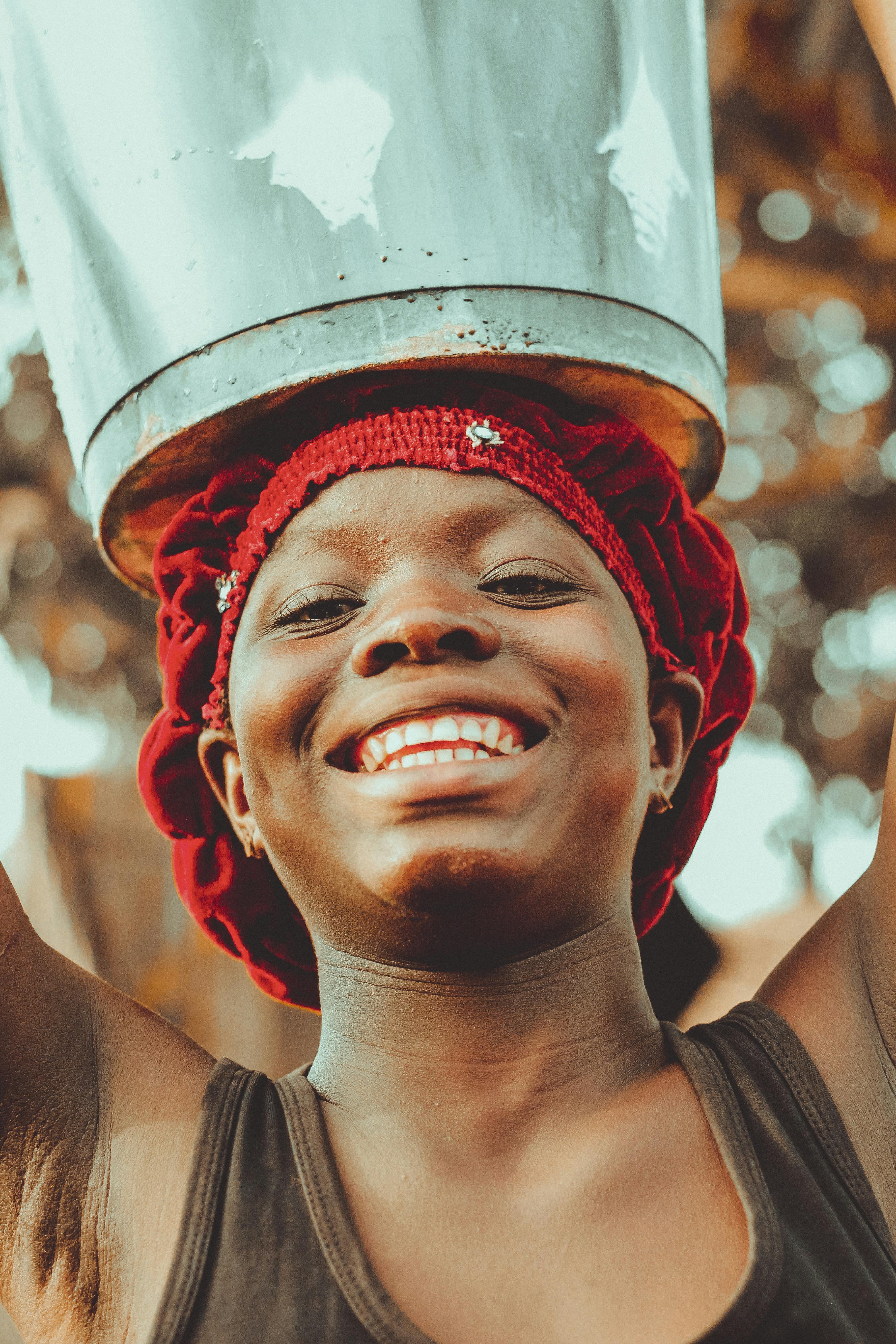 African Woman Holding Bucket on Head · Free Stock Photo