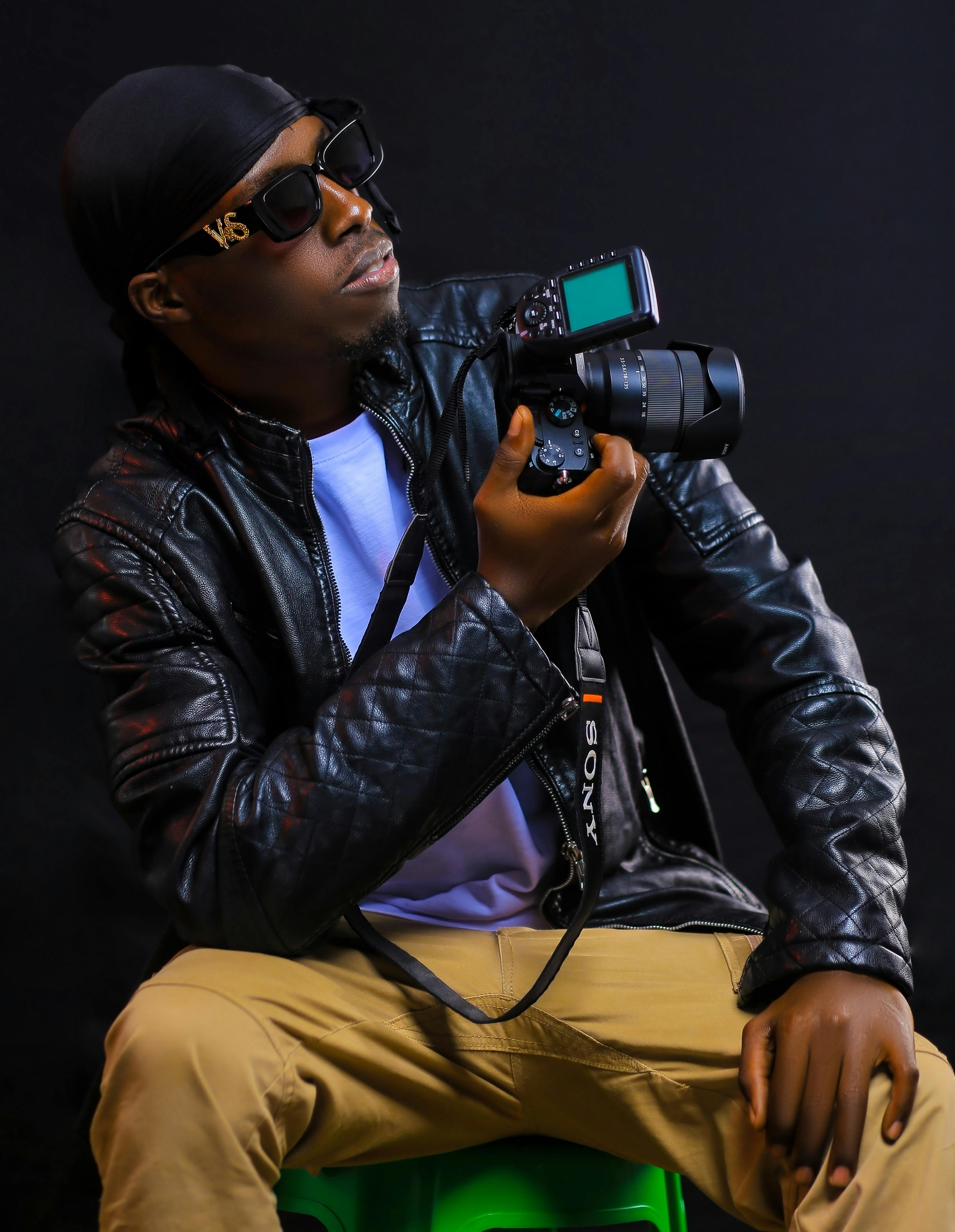 Man in Leather Jacket Holding a Camere · Free Stock Photo