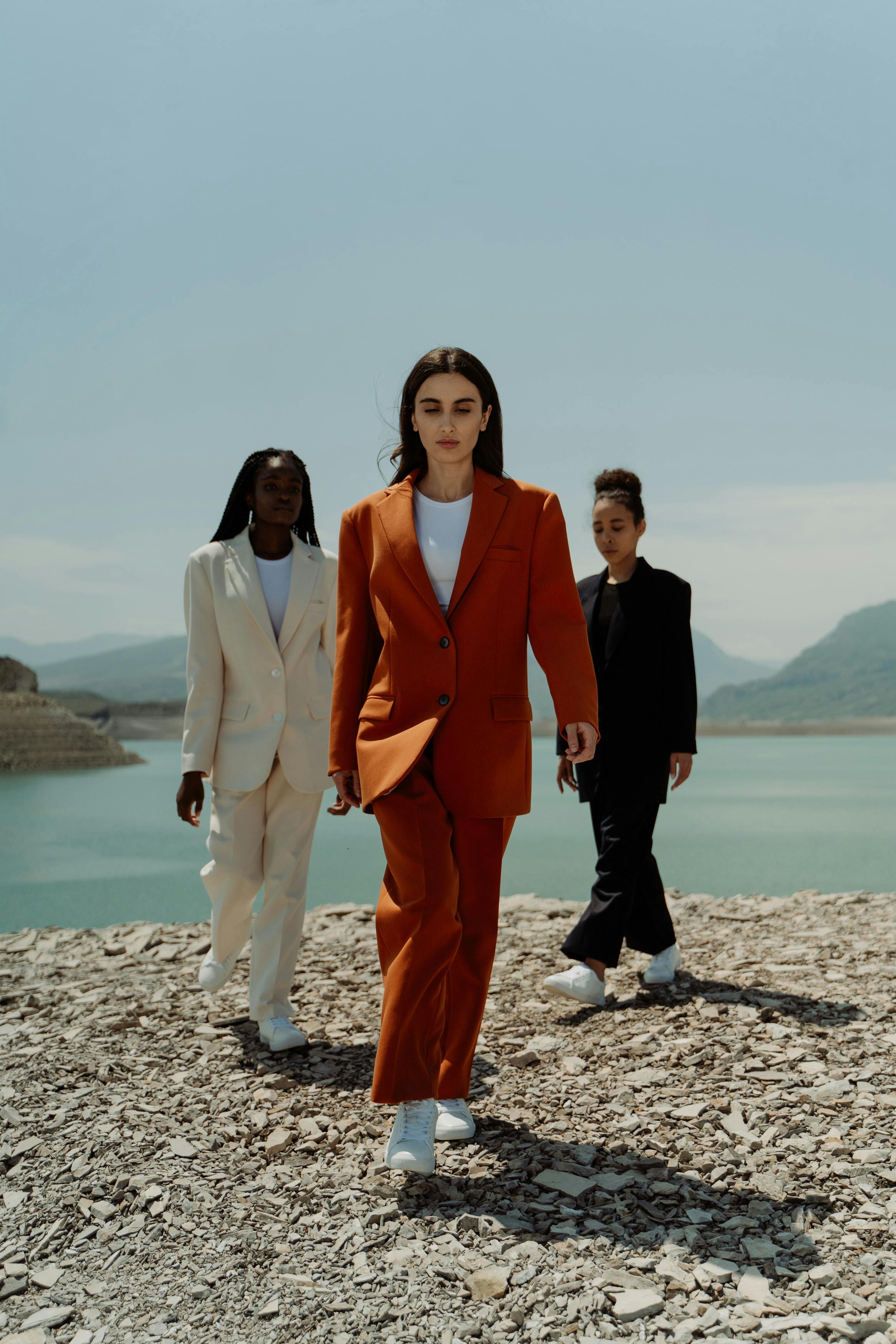 Women in Business Suits Walking on Rocky Ground · Free Stock Photo
