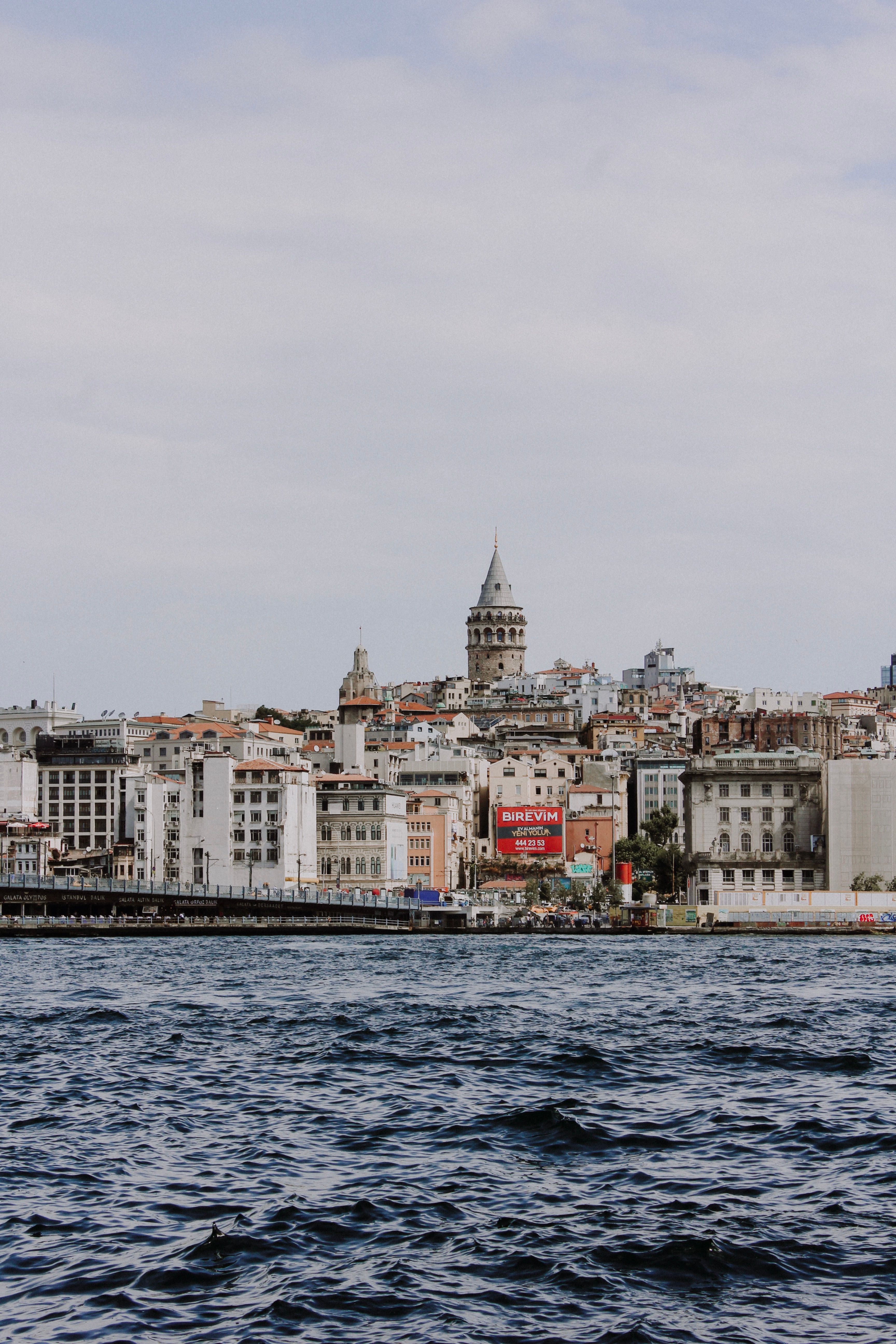 City Near Body of Water Under a Blue Sky · Free Stock Photo