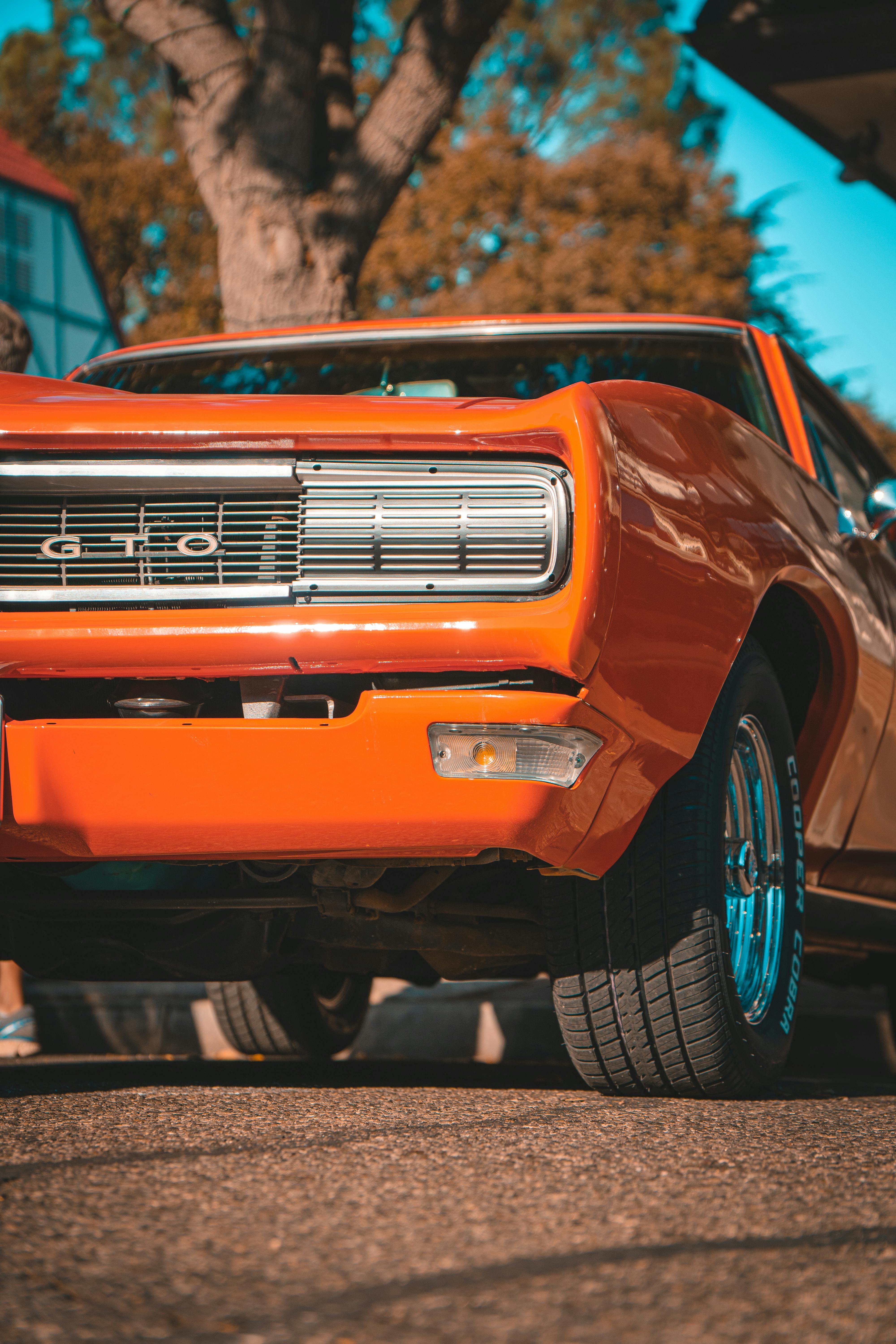 Orange Vintage Car Parked Near the Tree · Free Stock Photo