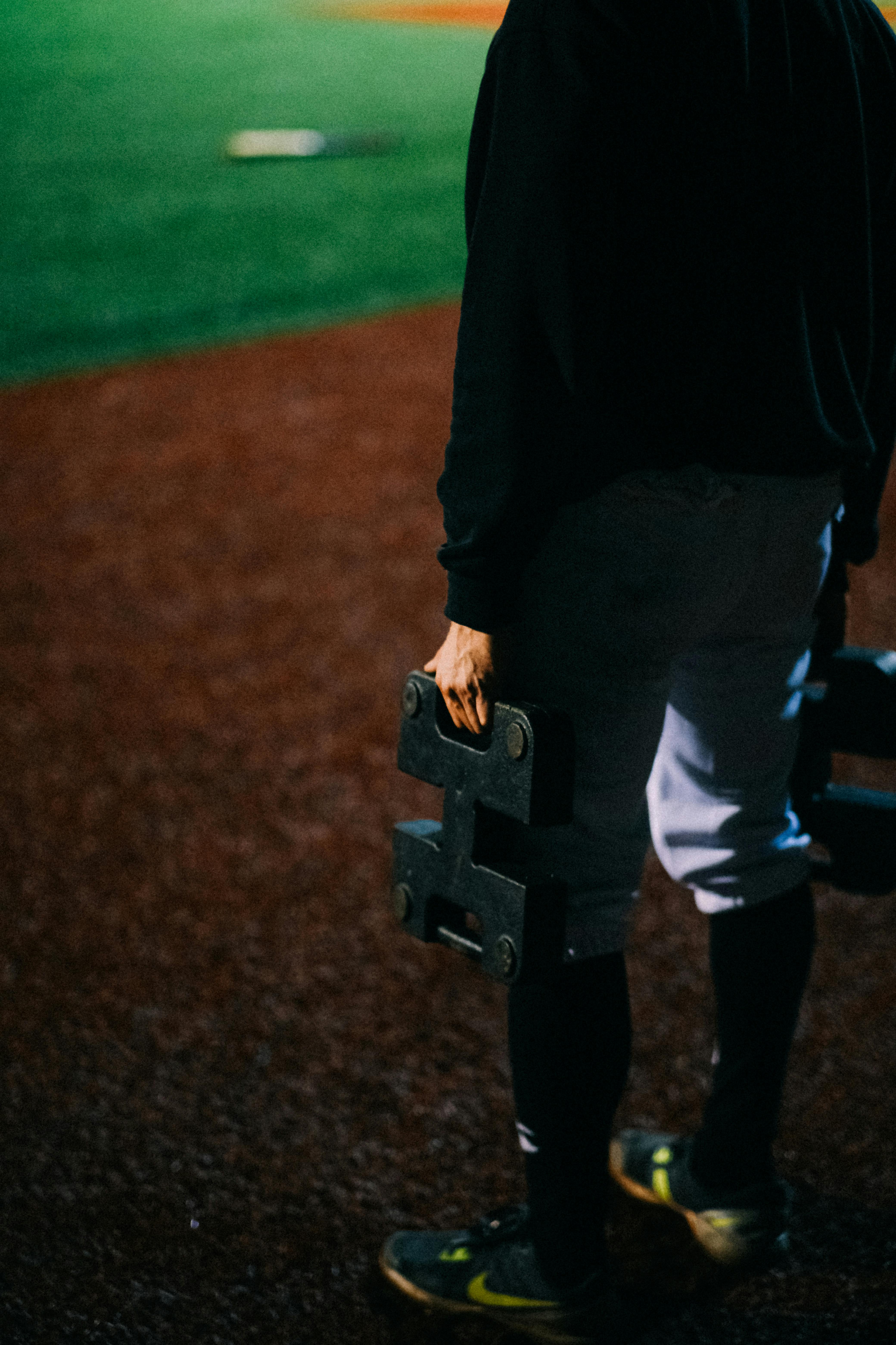Man Standing on a Football Pitch and Holding Squat Blocks · Free Stock ...