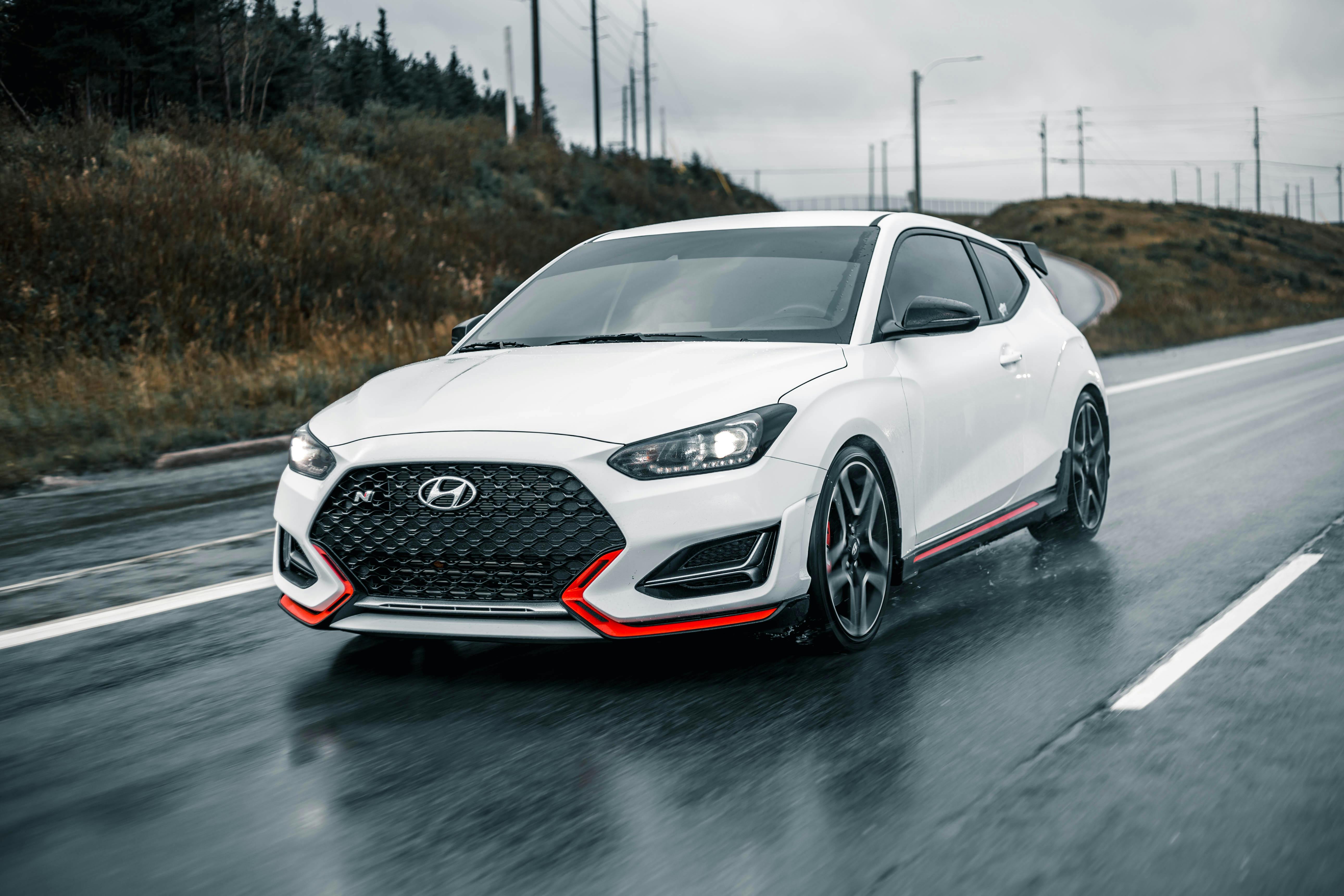 Front View of White Hyundai Car on Wet Road · Free Stock Photo