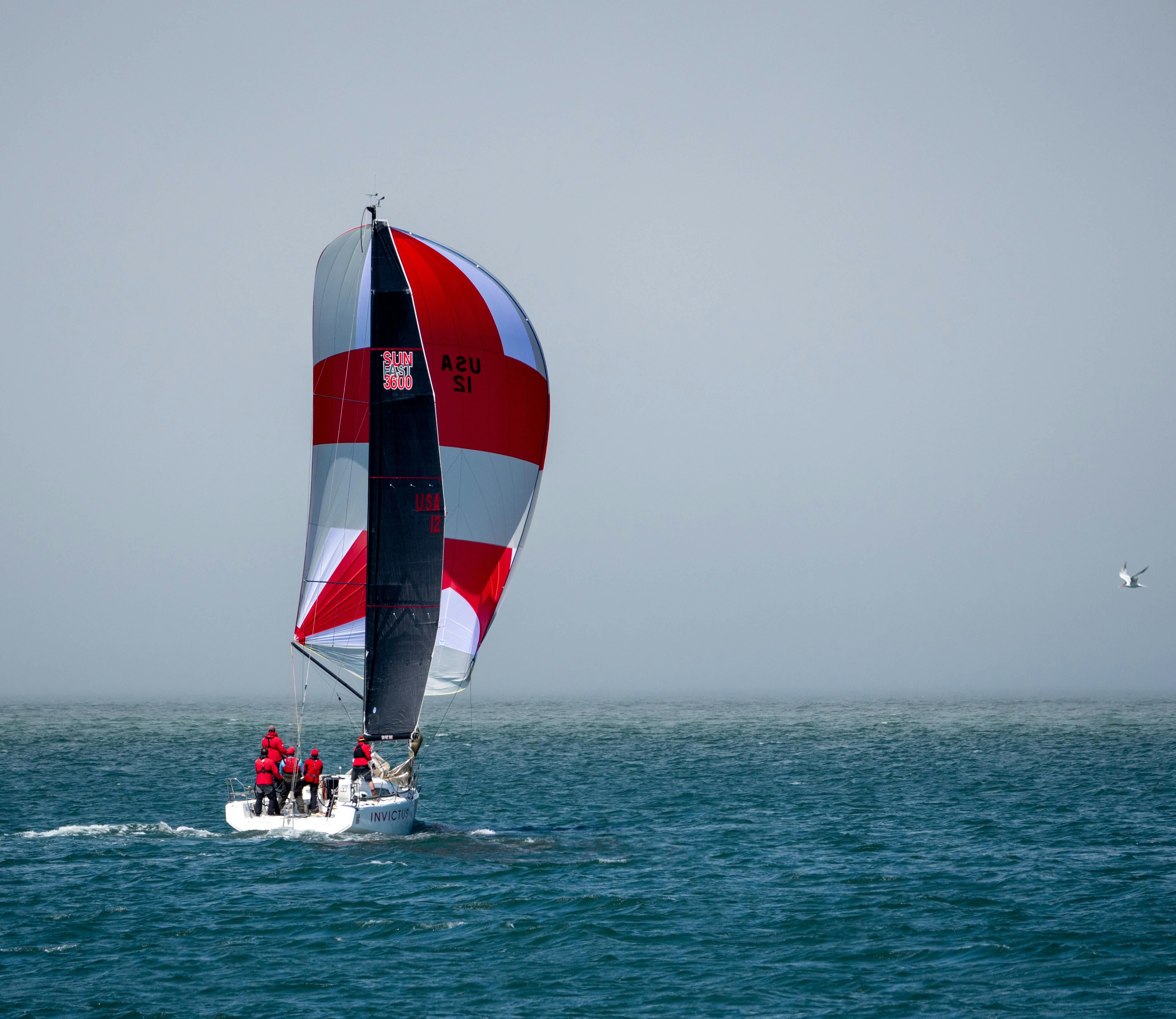 A Group of People Navigating a Sailboat · Free Stock Photo