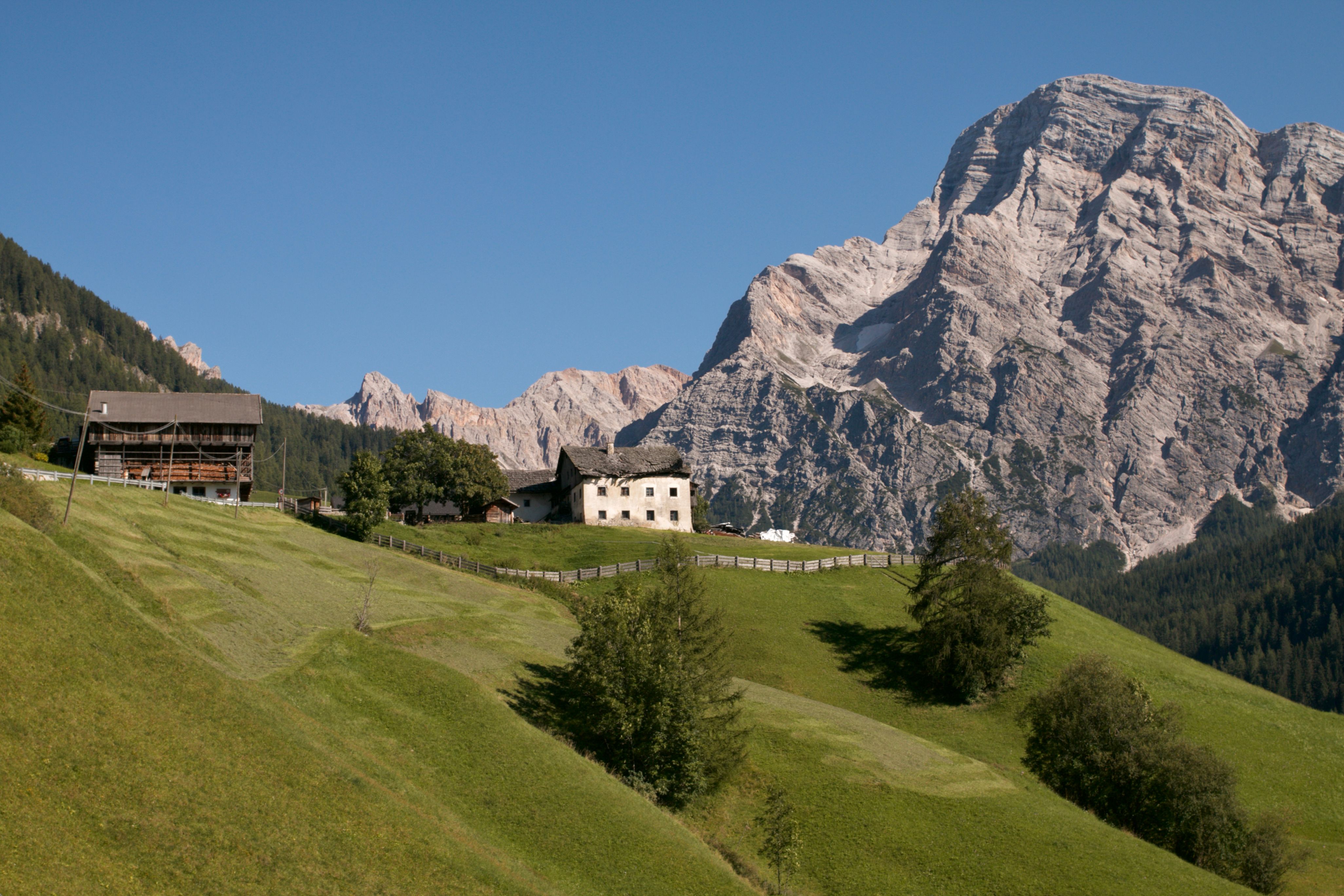 Castle in Green Valley near Rock Mountains · Free Stock Photo