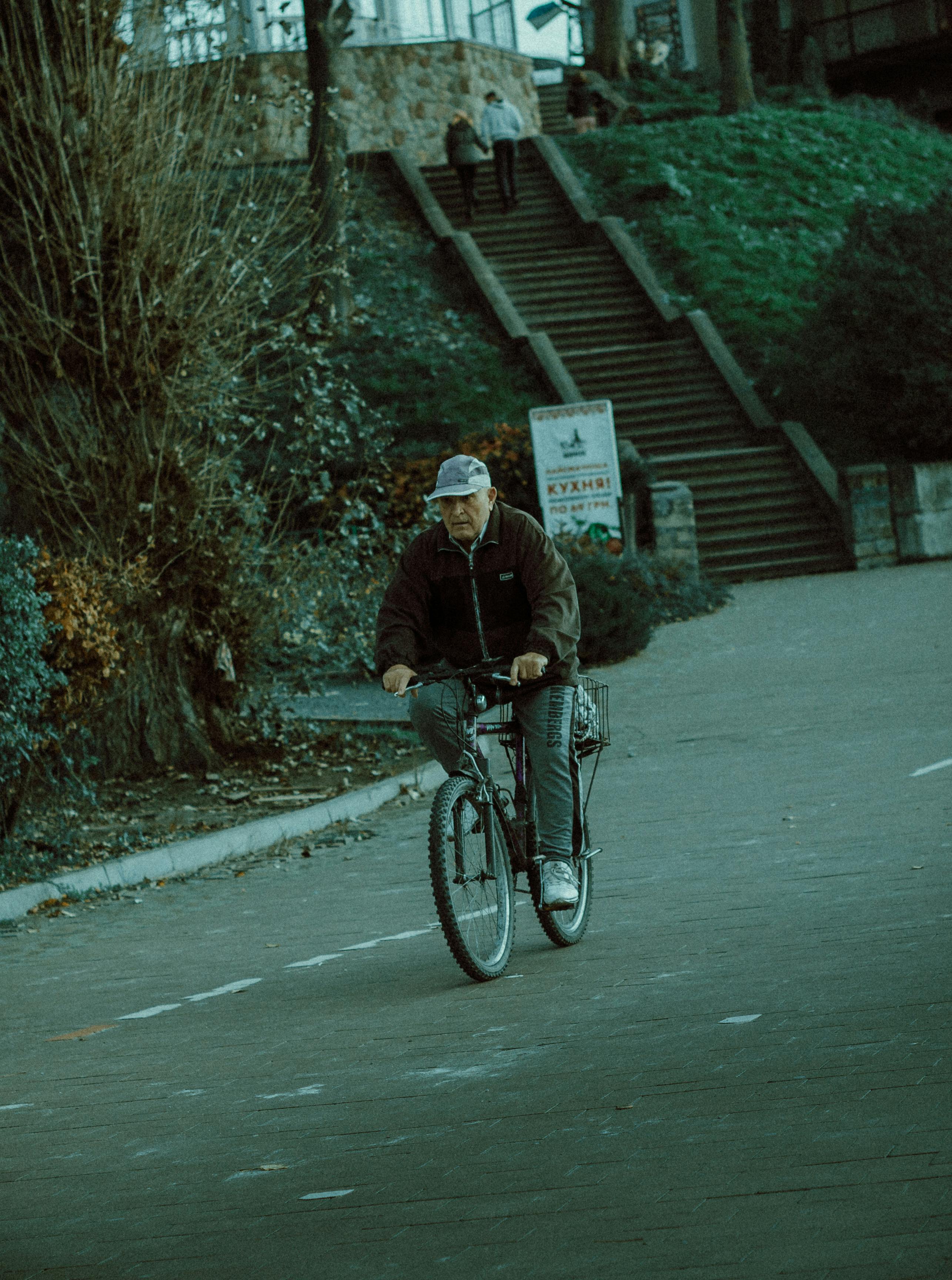 Man on Bicycle on Sidewalk · Free Stock Photo
