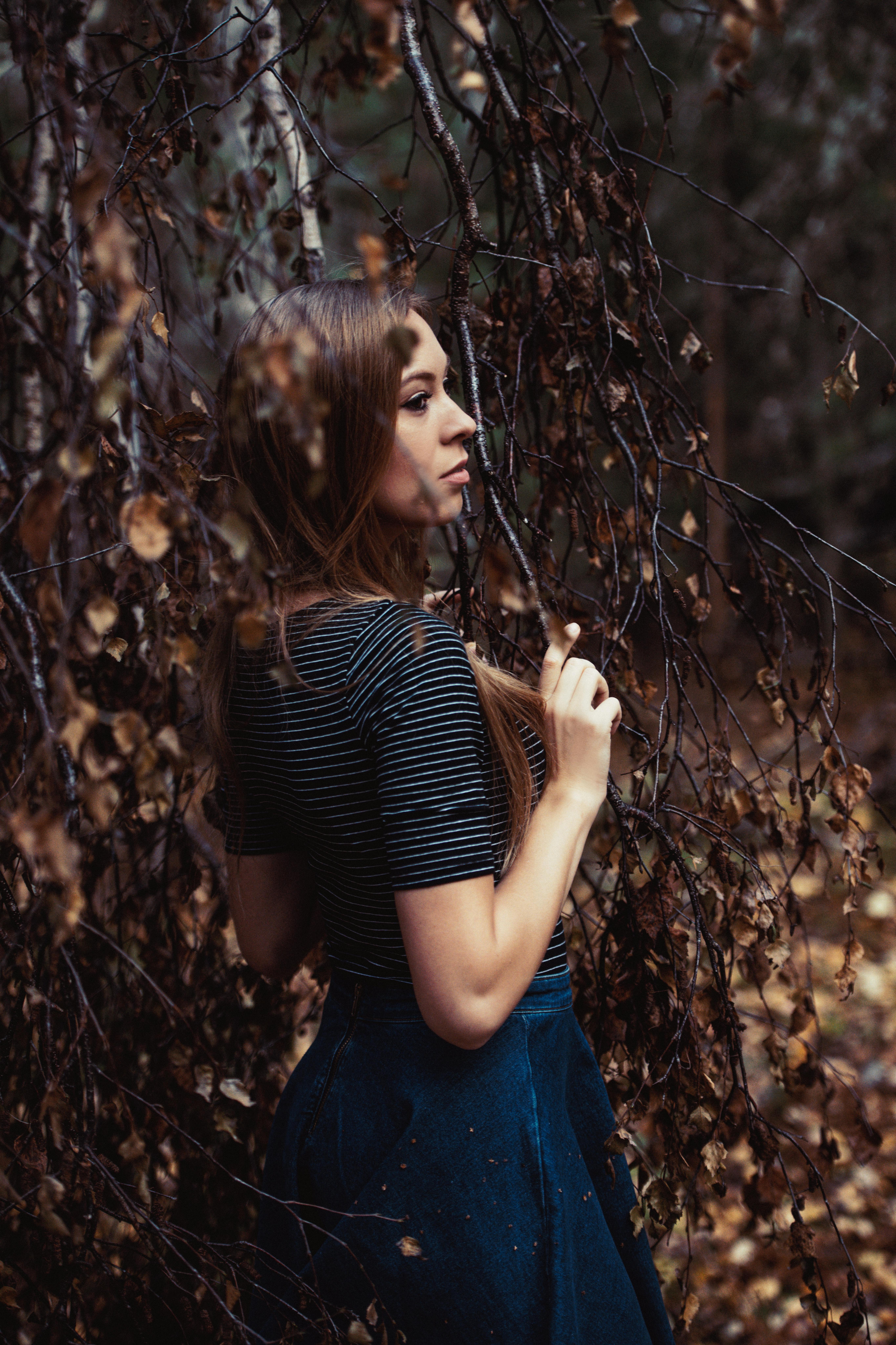 A Woman Standing Beside the Tree · Free Stock Photo