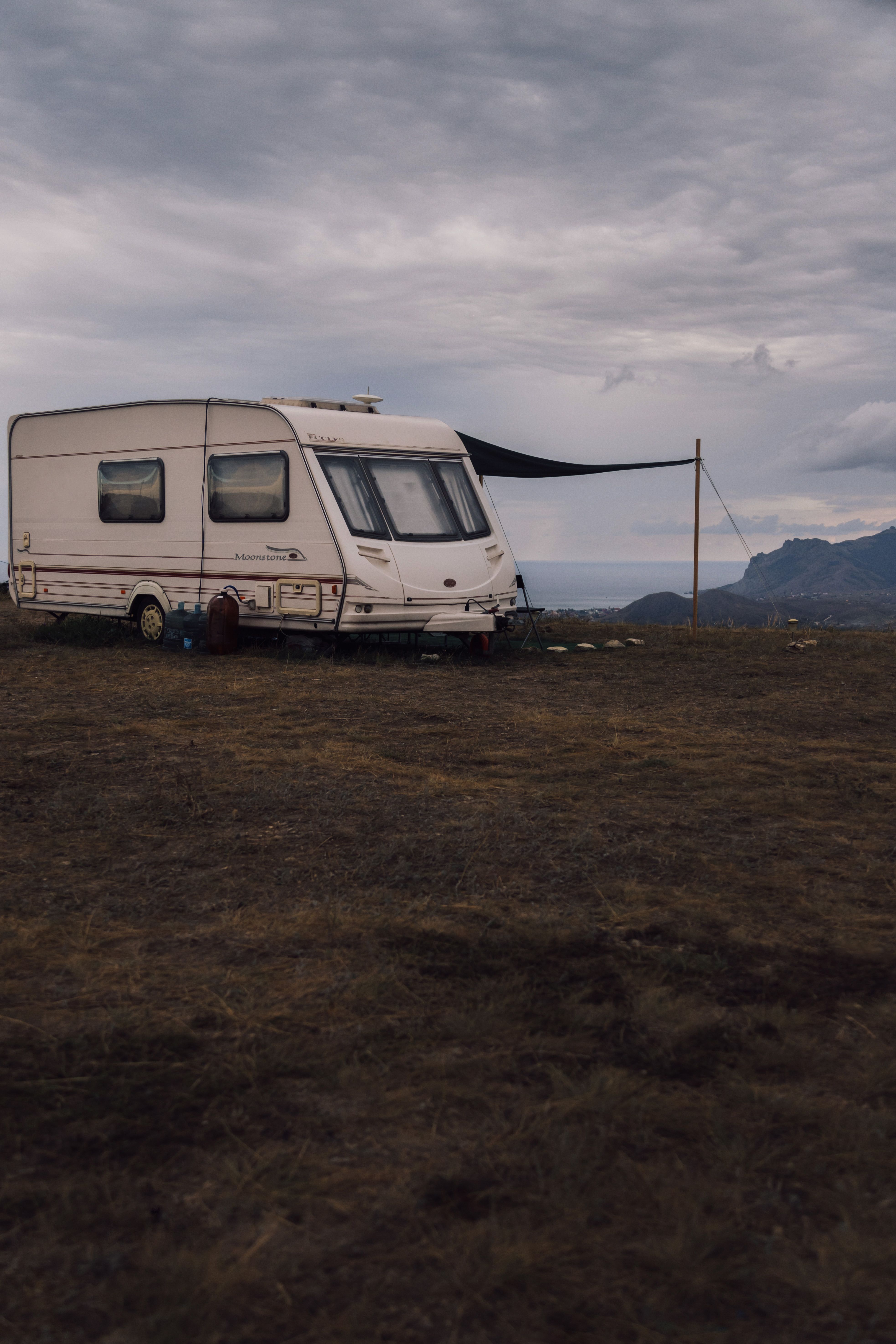 Camper Trailer Parked in Green Grass · Free Stock Photo