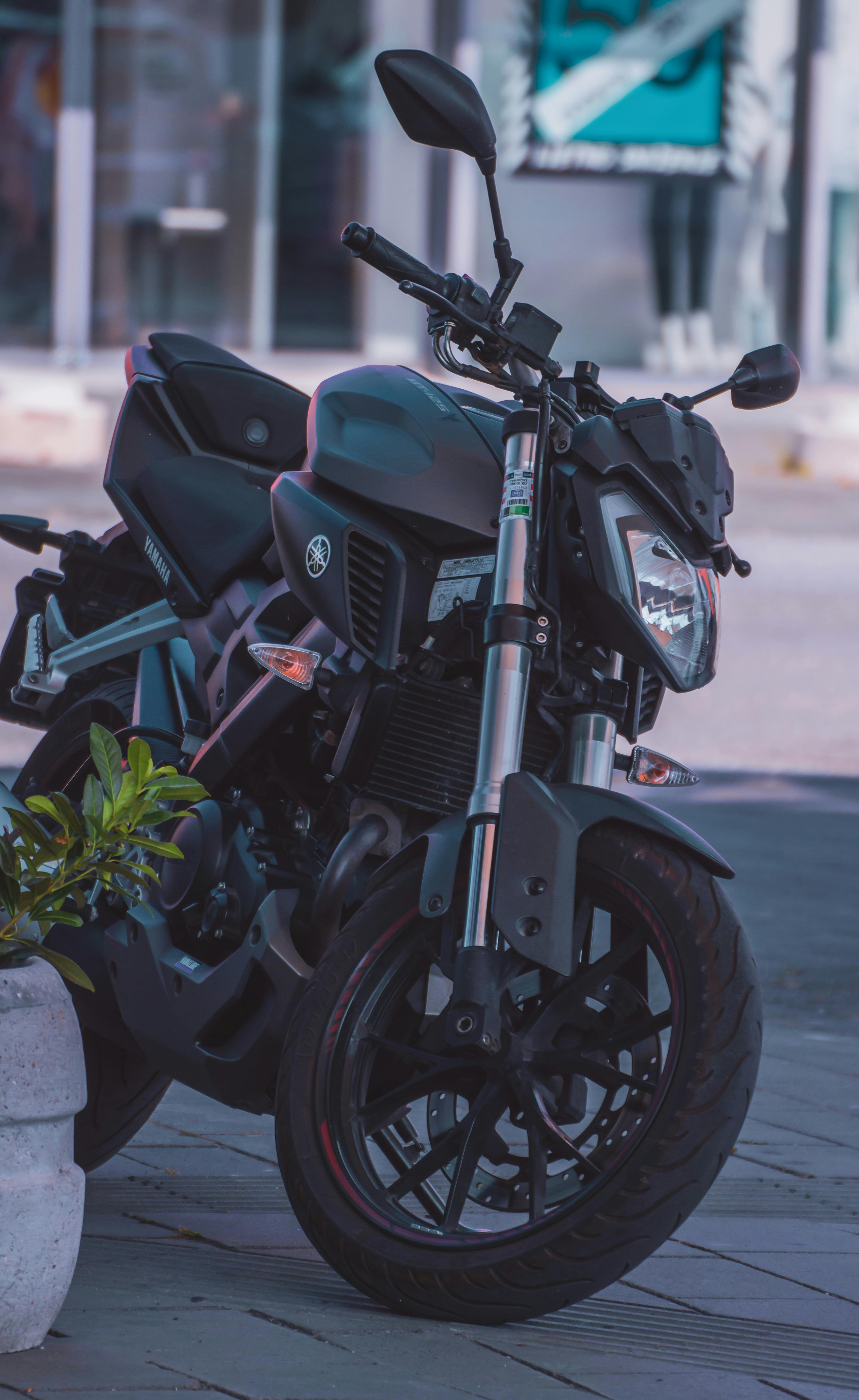 Motorbikes Parked in Garage Cluttered with Mechanic Eq · Free Stock Photo