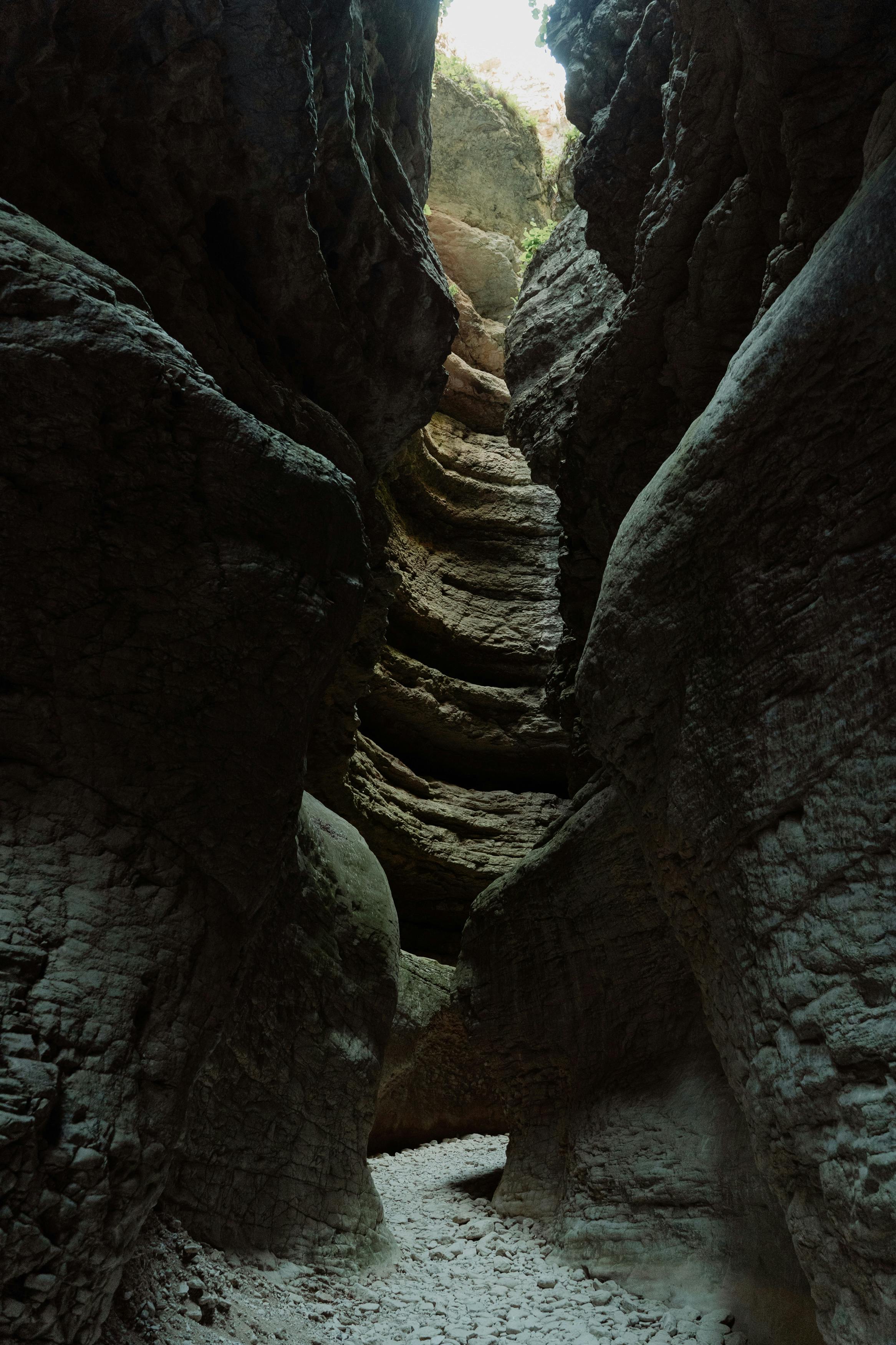Person Under Black and Gray Cliff · Free Stock Photo