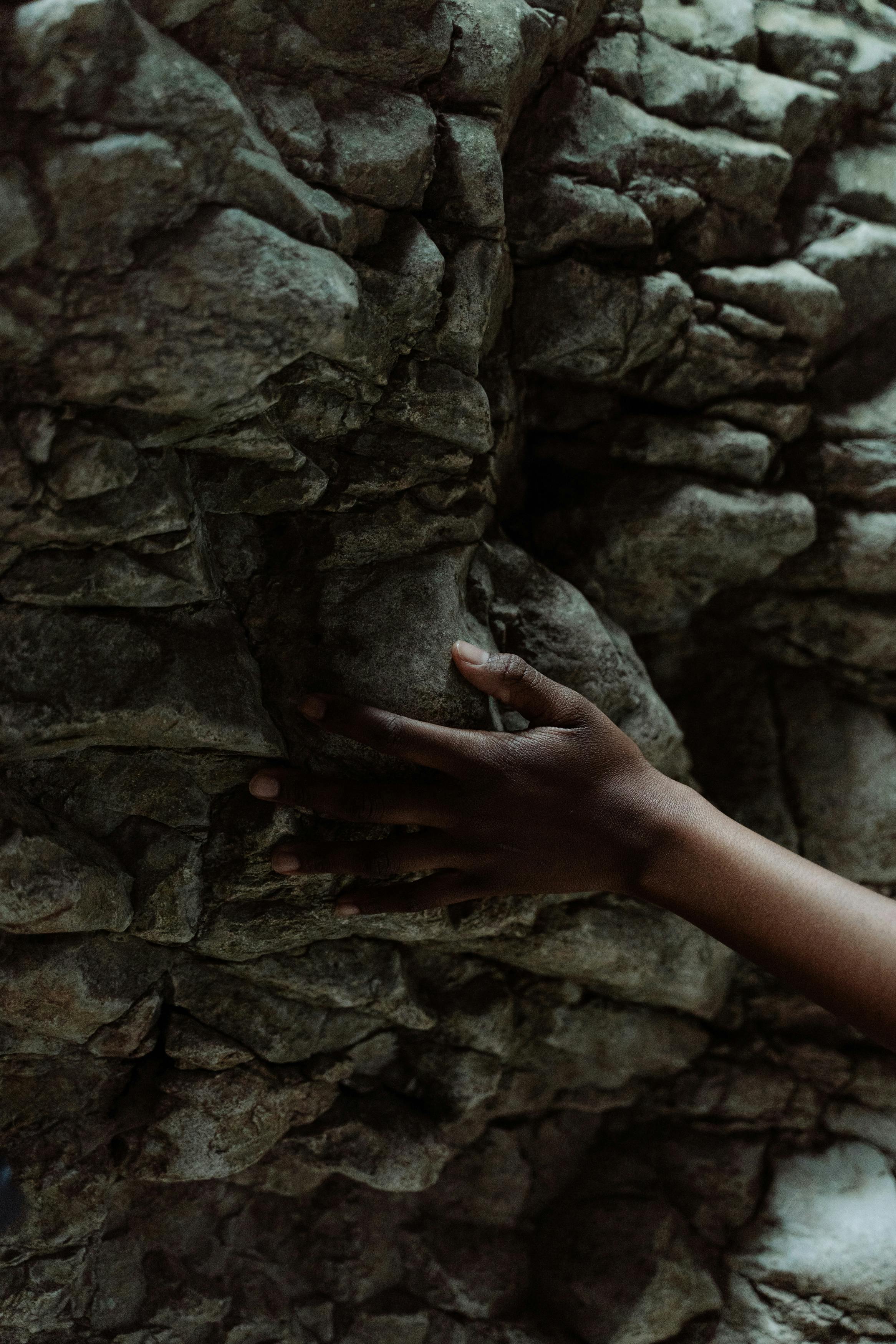 Woman Touching Rough Rock · Free Stock Photo