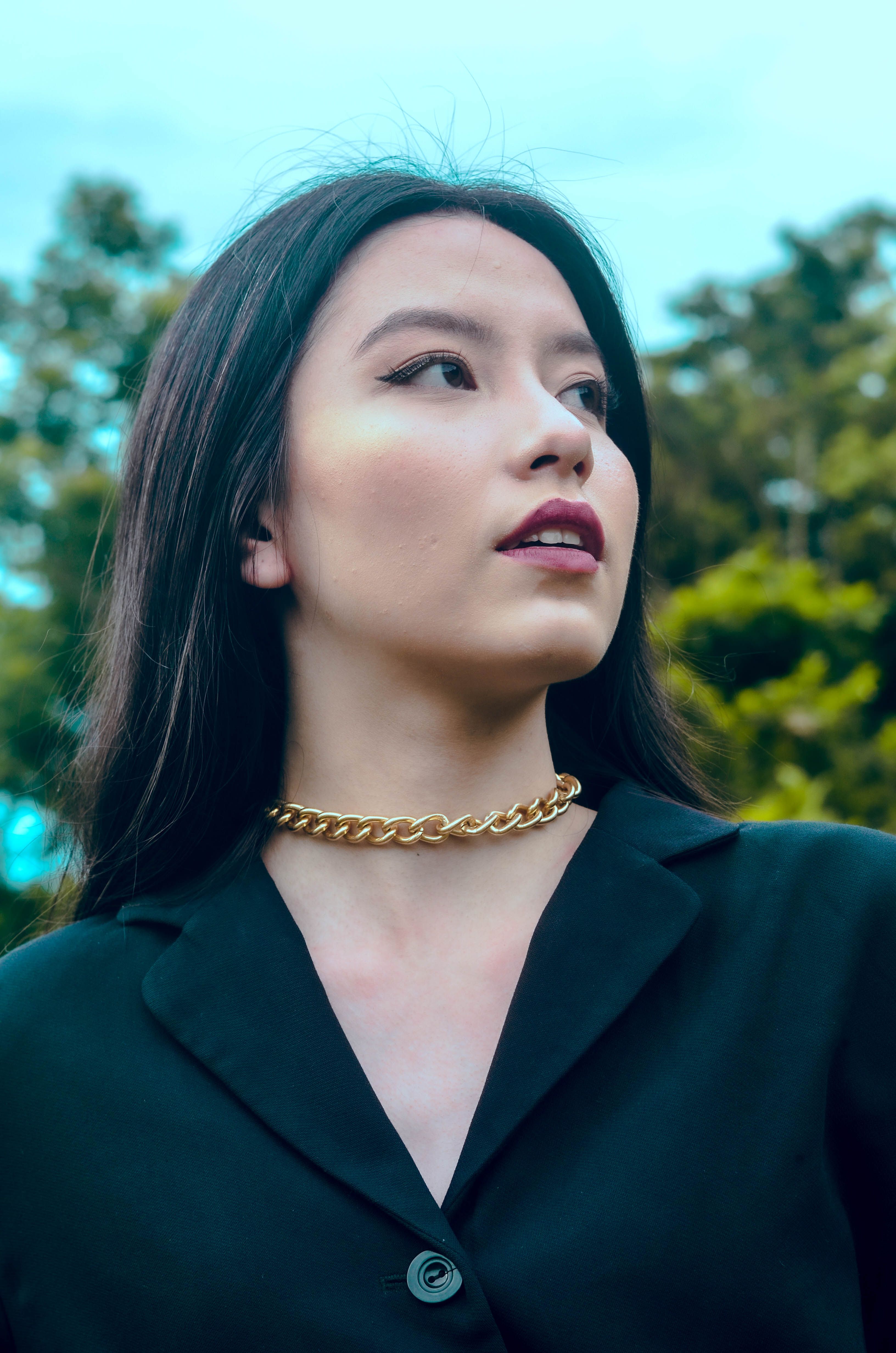 Close Up Photo of Woman Wearing Gold Chain Necklace · Free Stock Photo