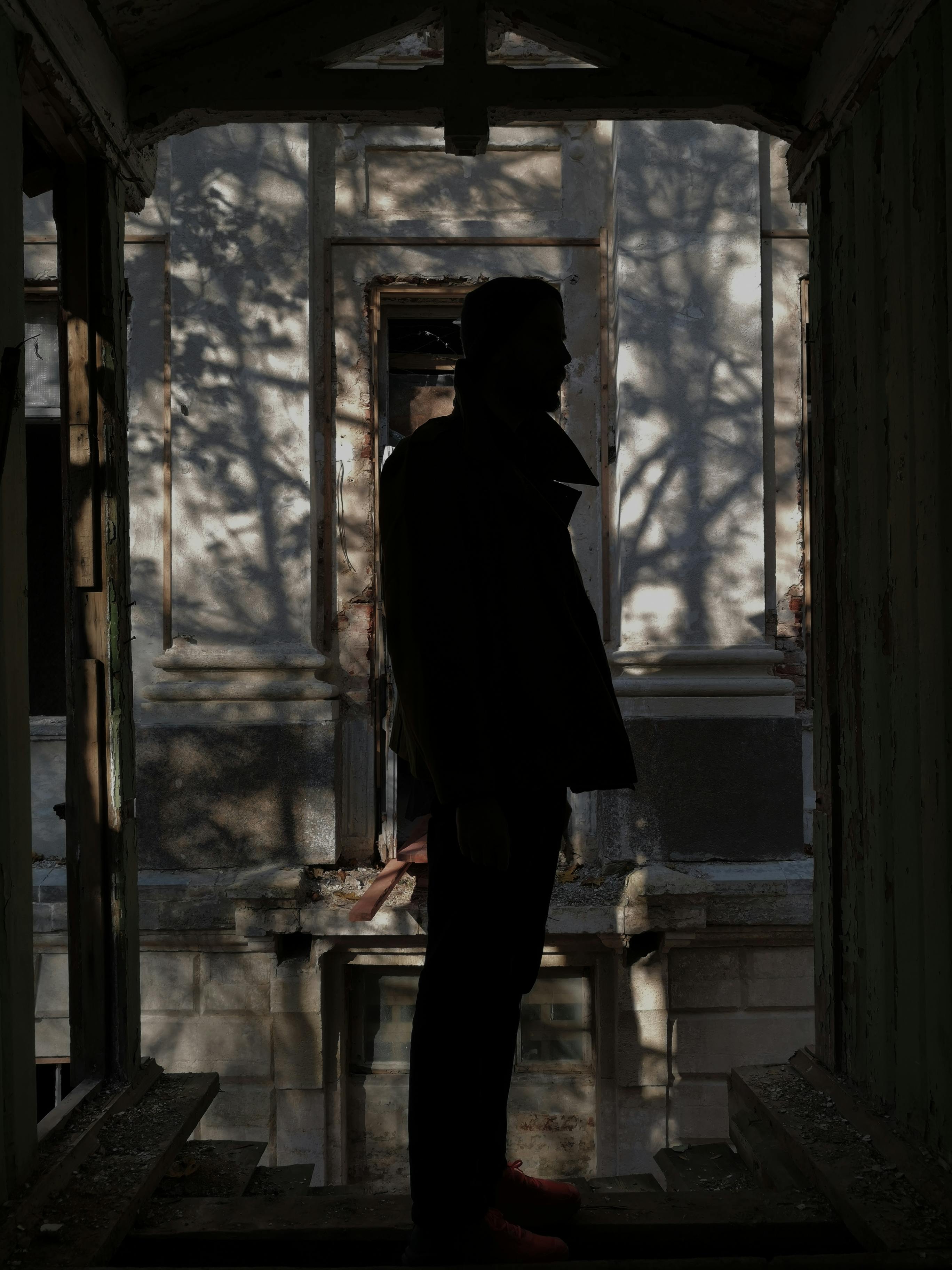 A Person Standing Near an Open Window · Free Stock Photo