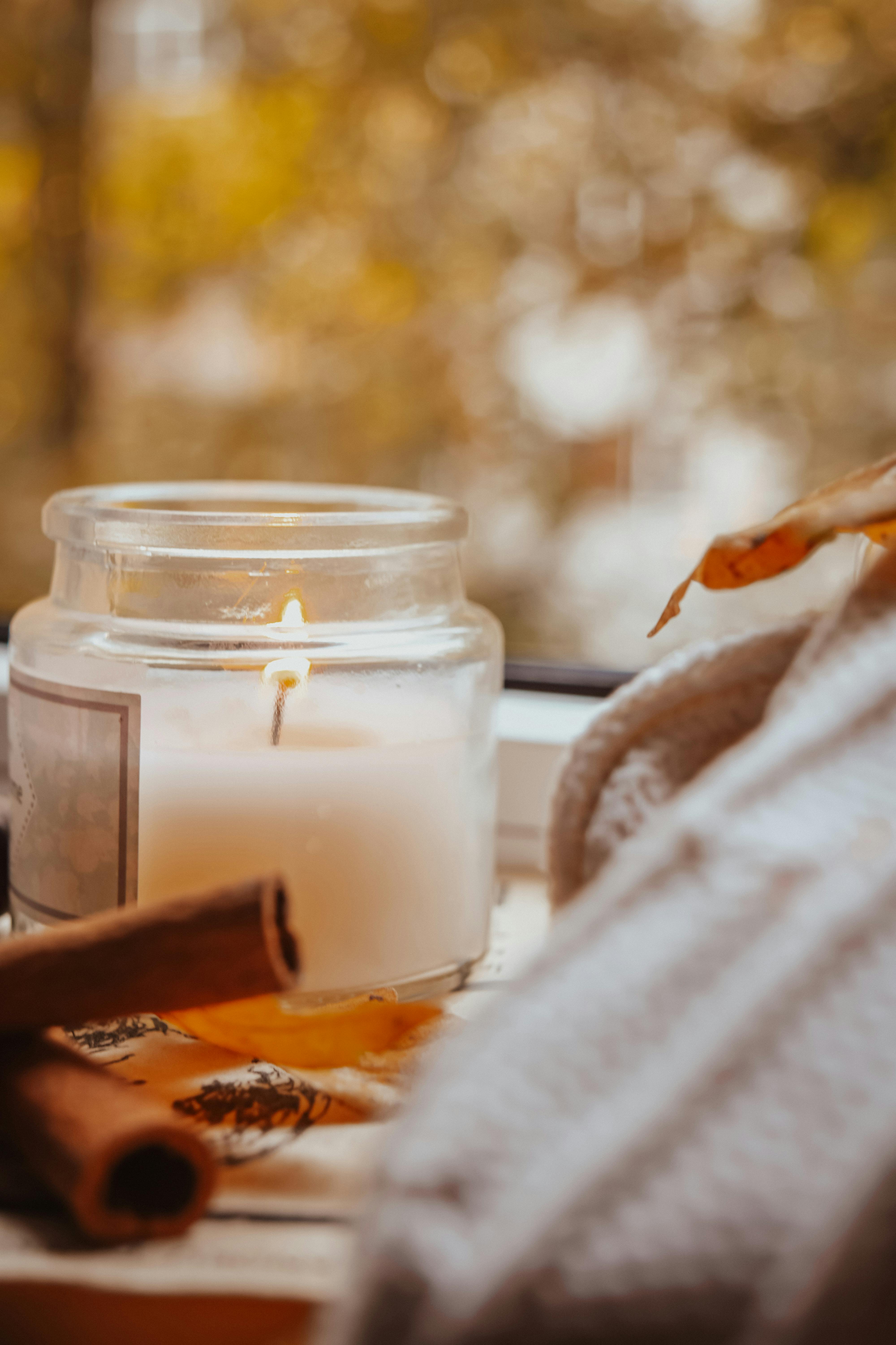 A Close-Up Shot of a Lighted Scented Candle · Free Stock Photo