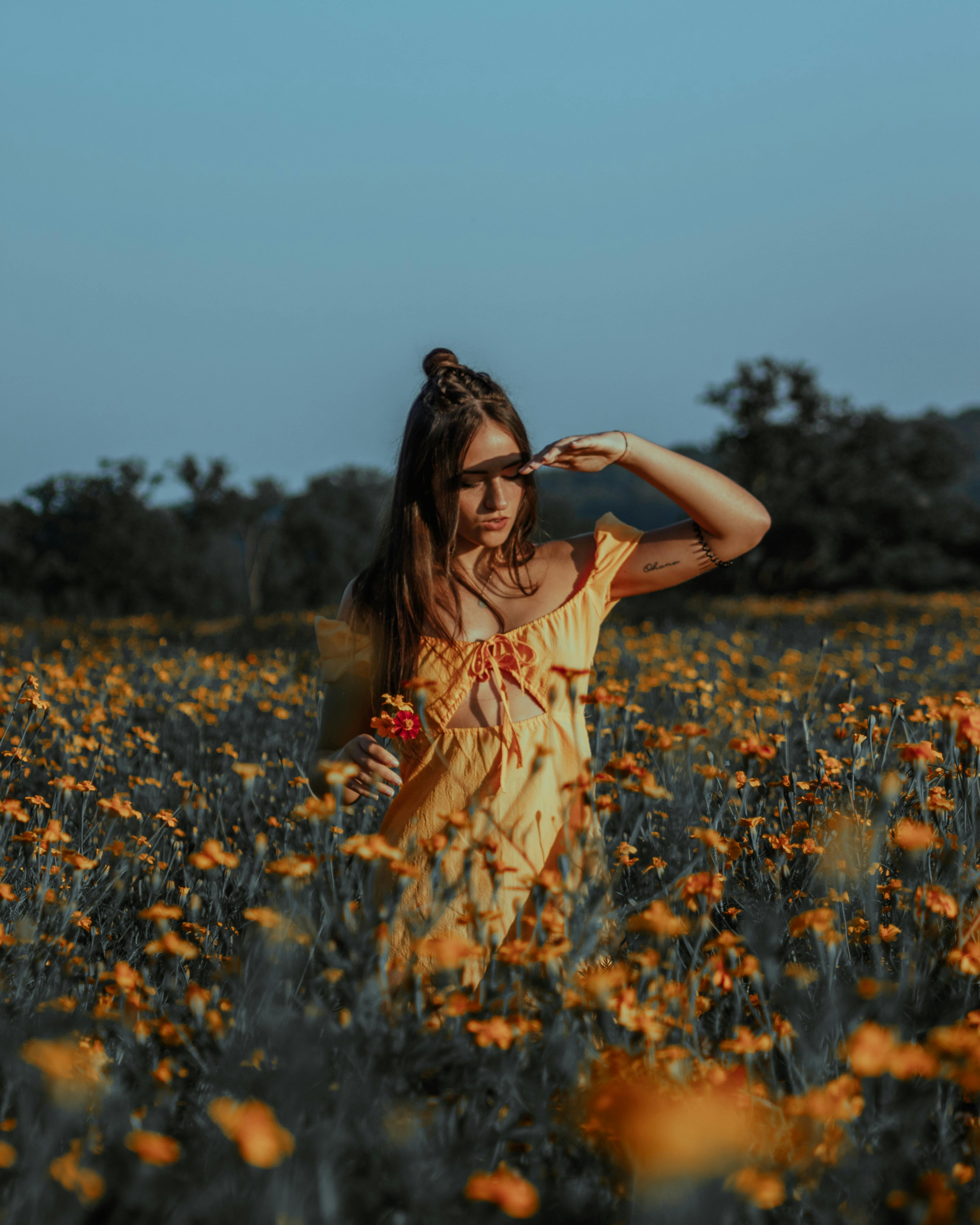 Girl in Floral Dress Standing on Orange Flower Field · Free Stock Photo