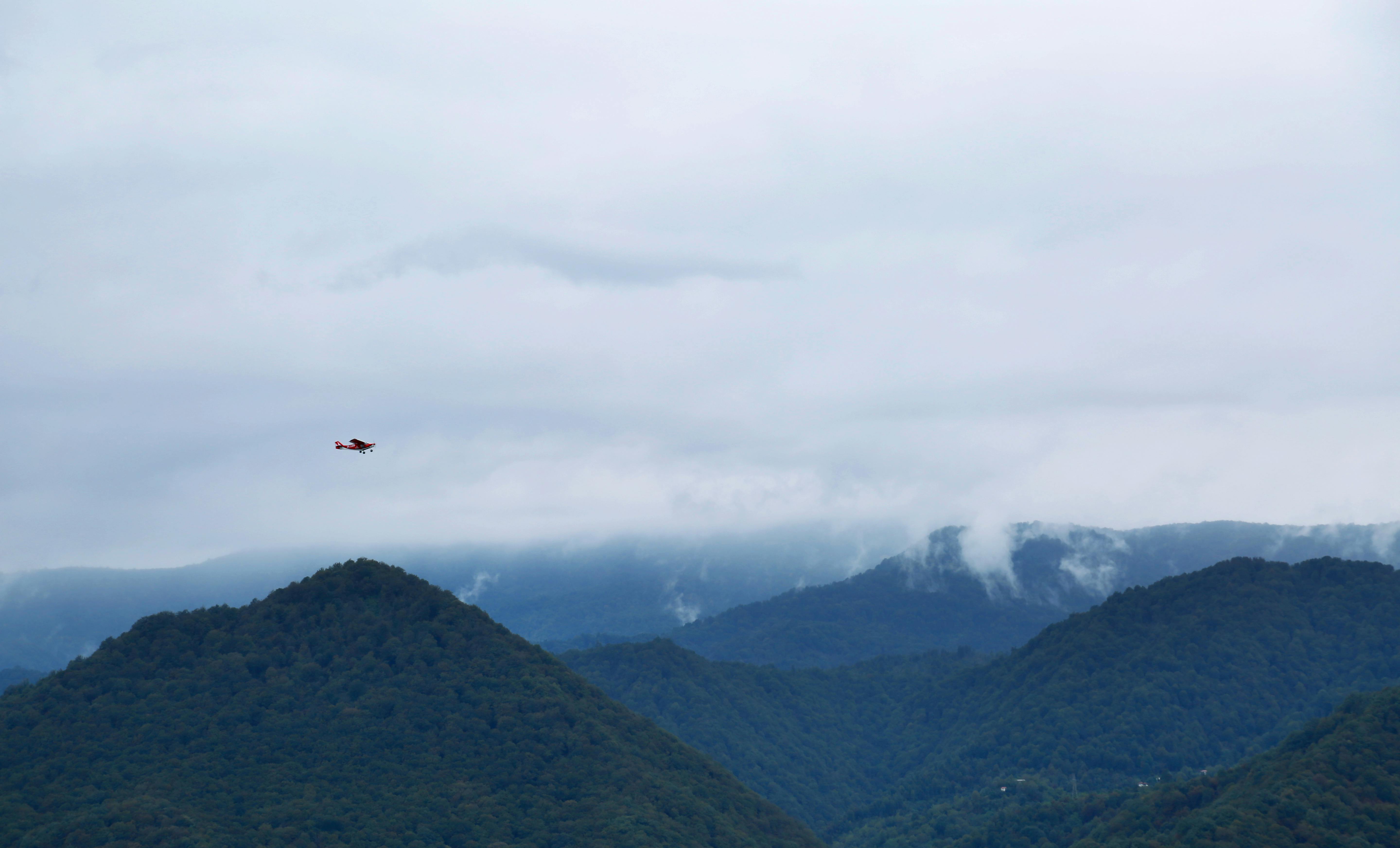 Light Aircraft Flying over a Mountain · Free Stock Photo