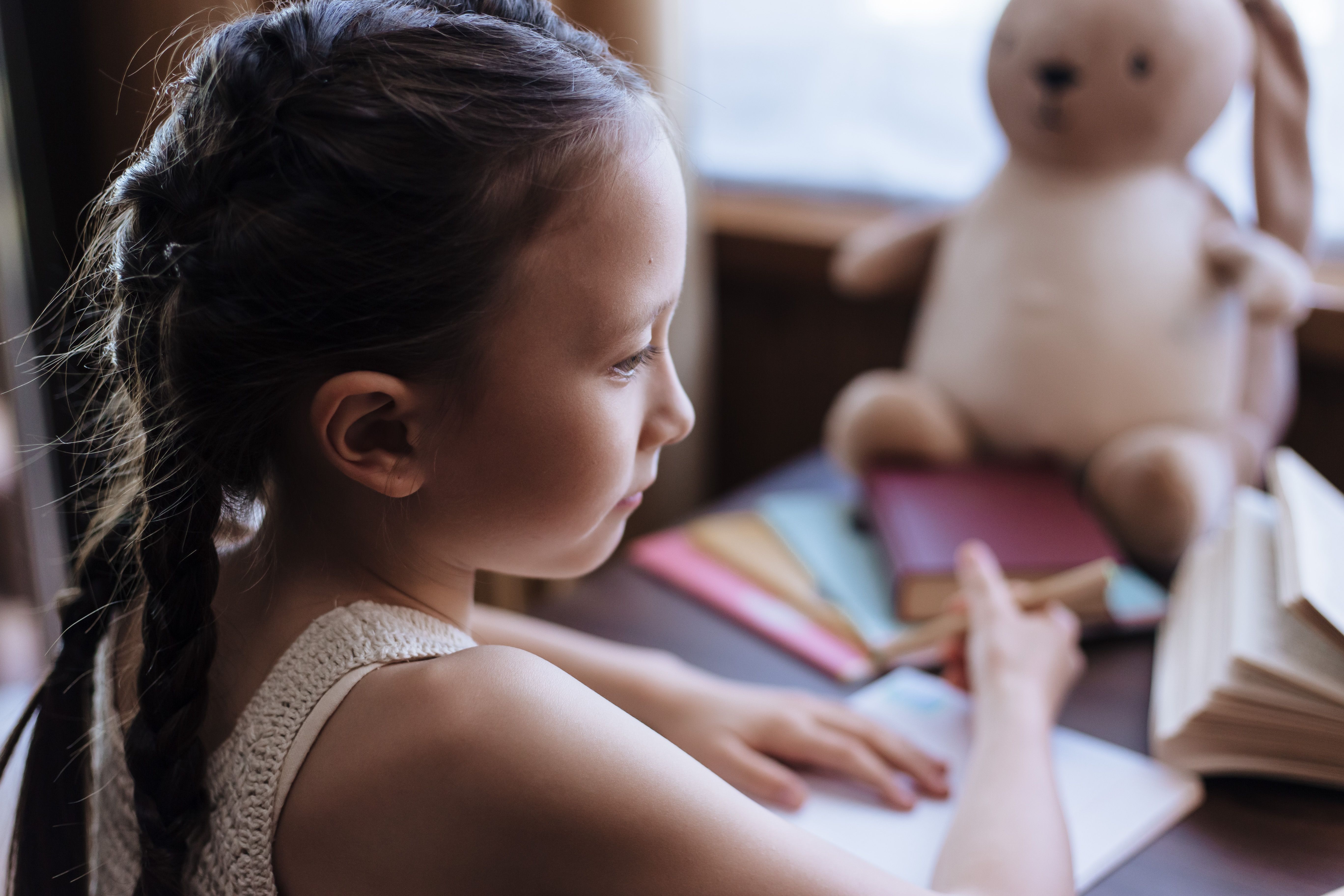 A Side View of Little Girl Drawing · Free Stock Photo