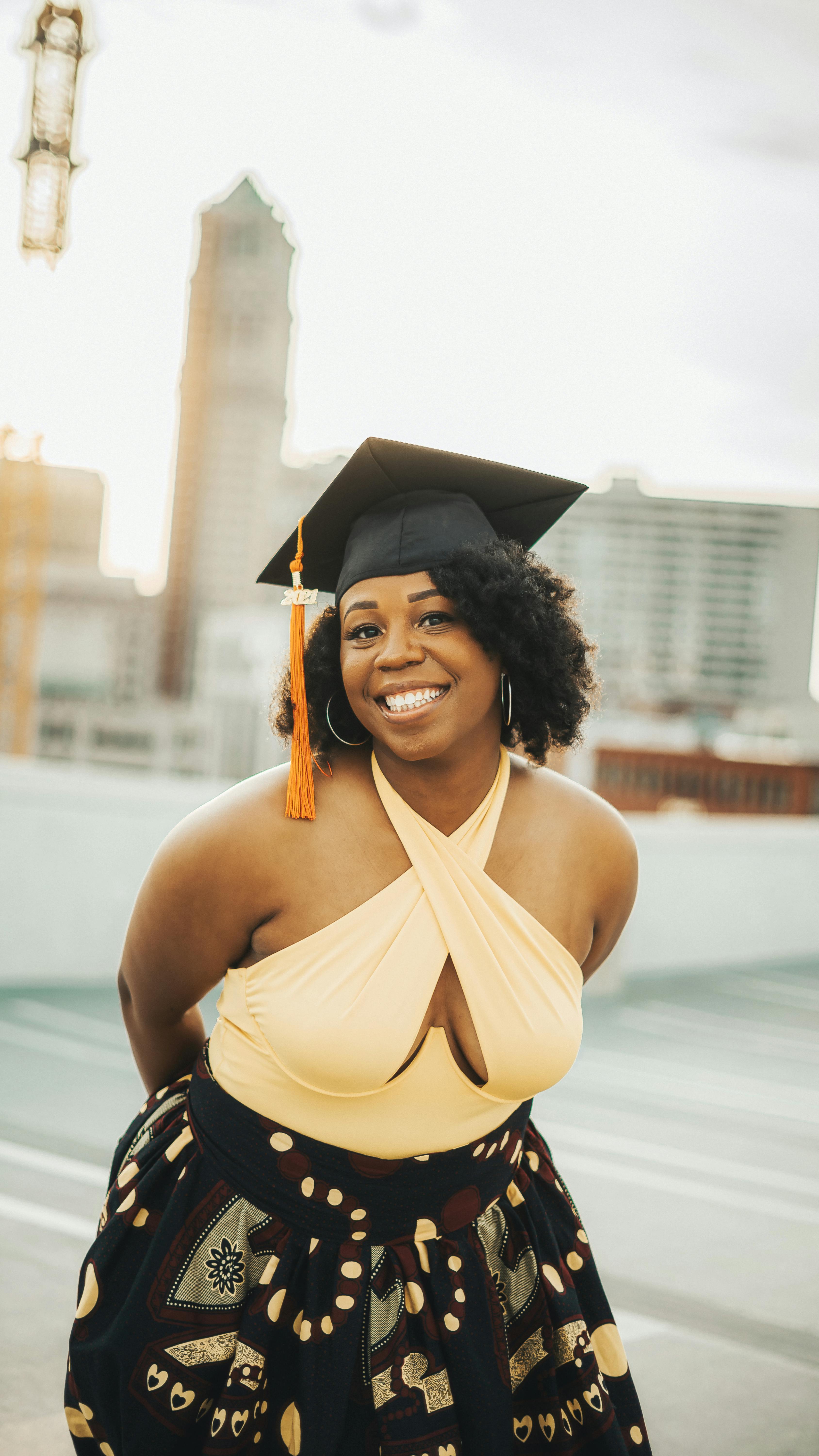 Happy College Graduate in Graduation Attire · Free Stock Photo