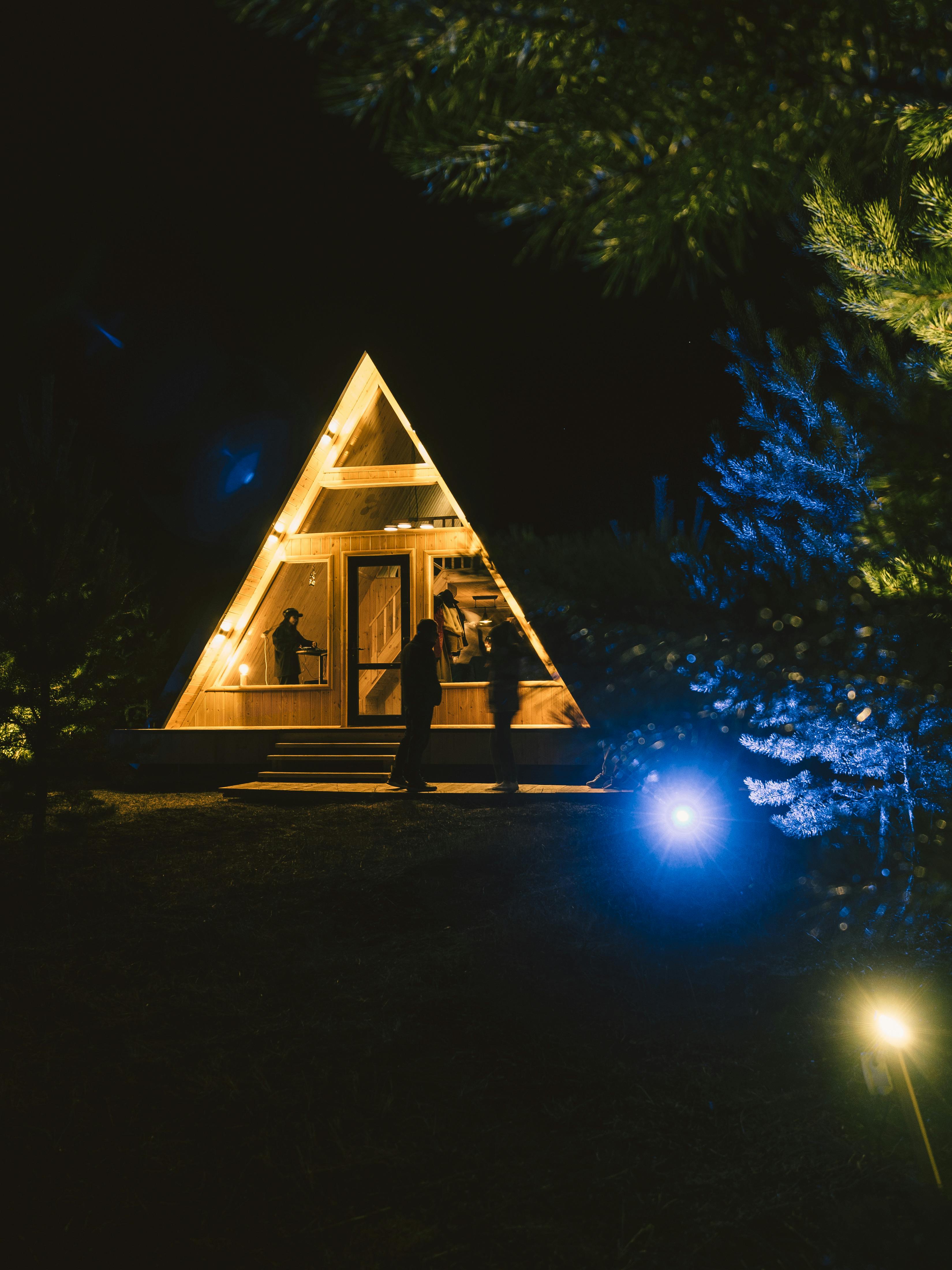 Illuminated Wooden Gable Cabin during Nighttime · Free Stock Photo