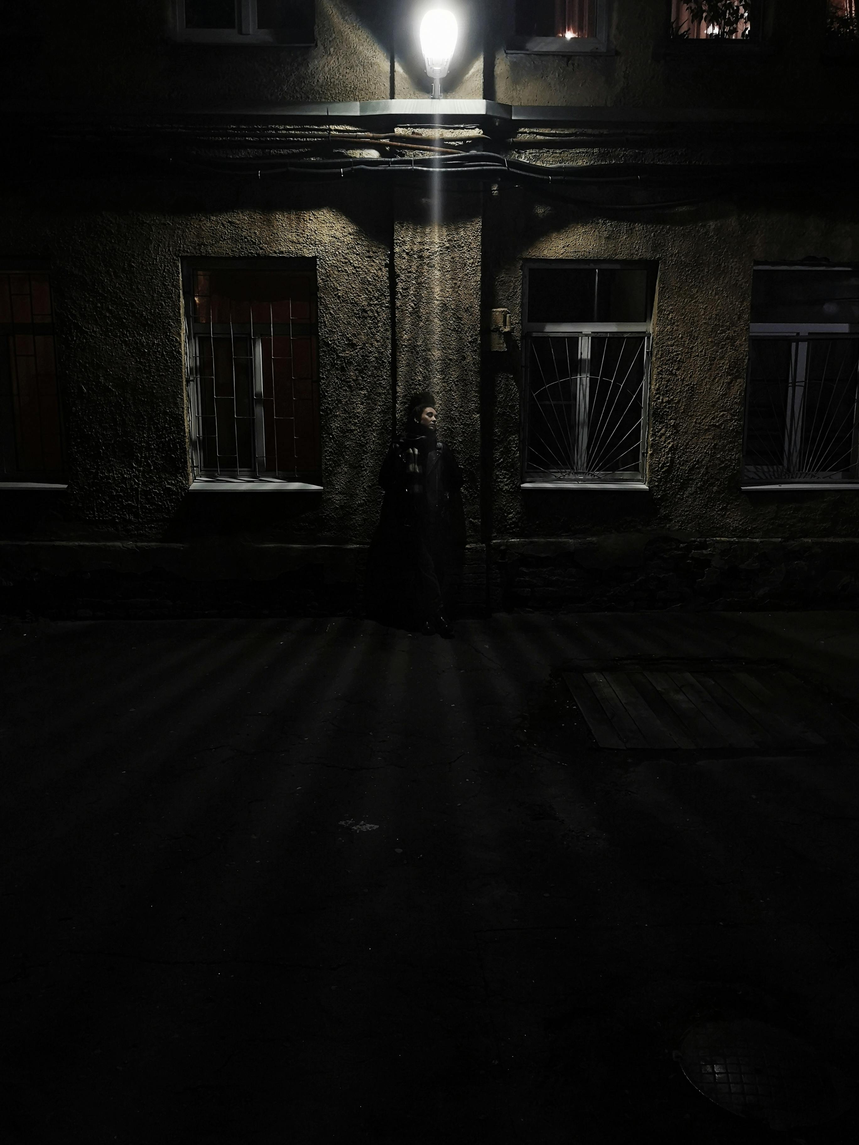 Multi Story House by the Concrete Street Lit by the Warm Street Light ...